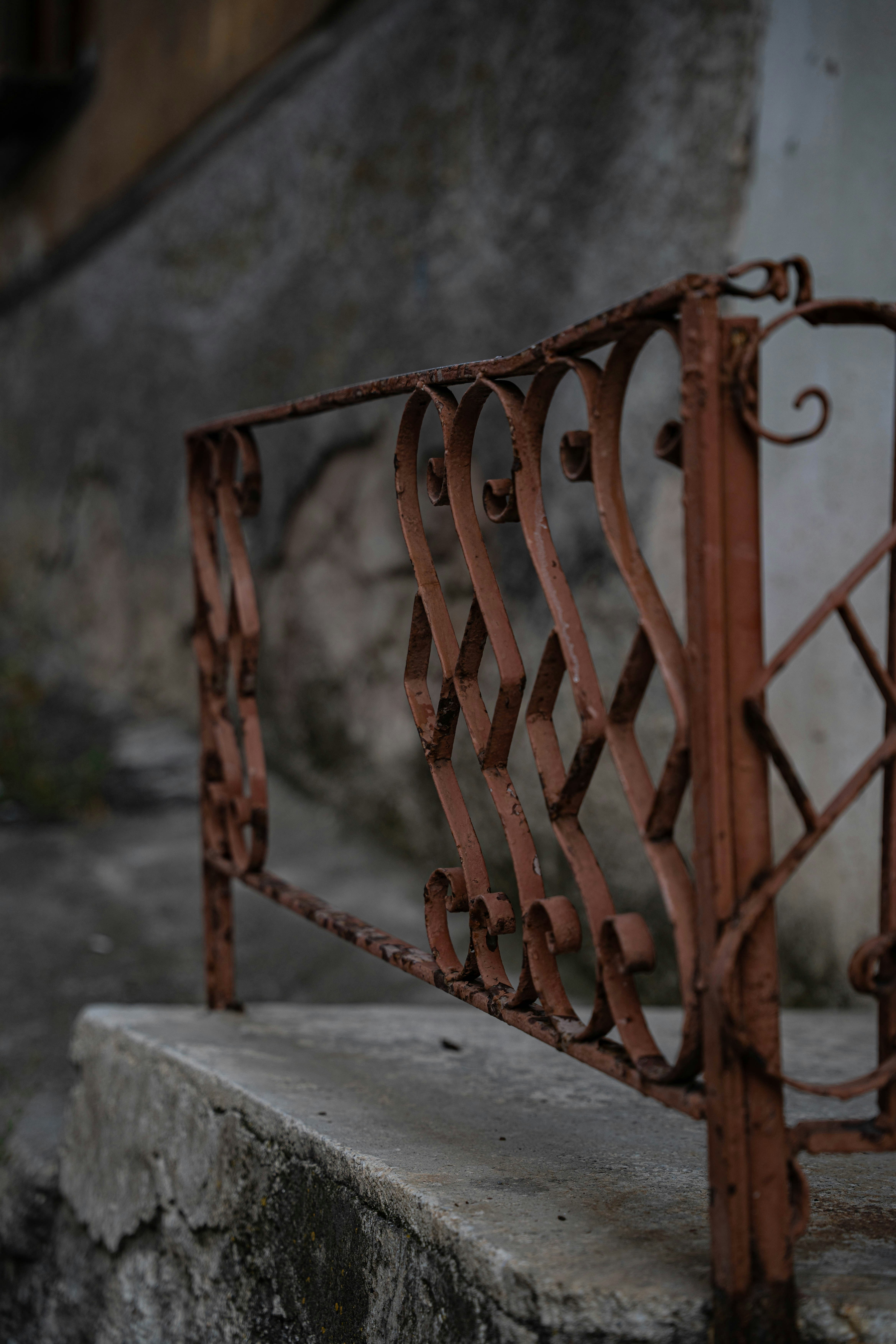 Rusty railing whispers of abandoned stairs