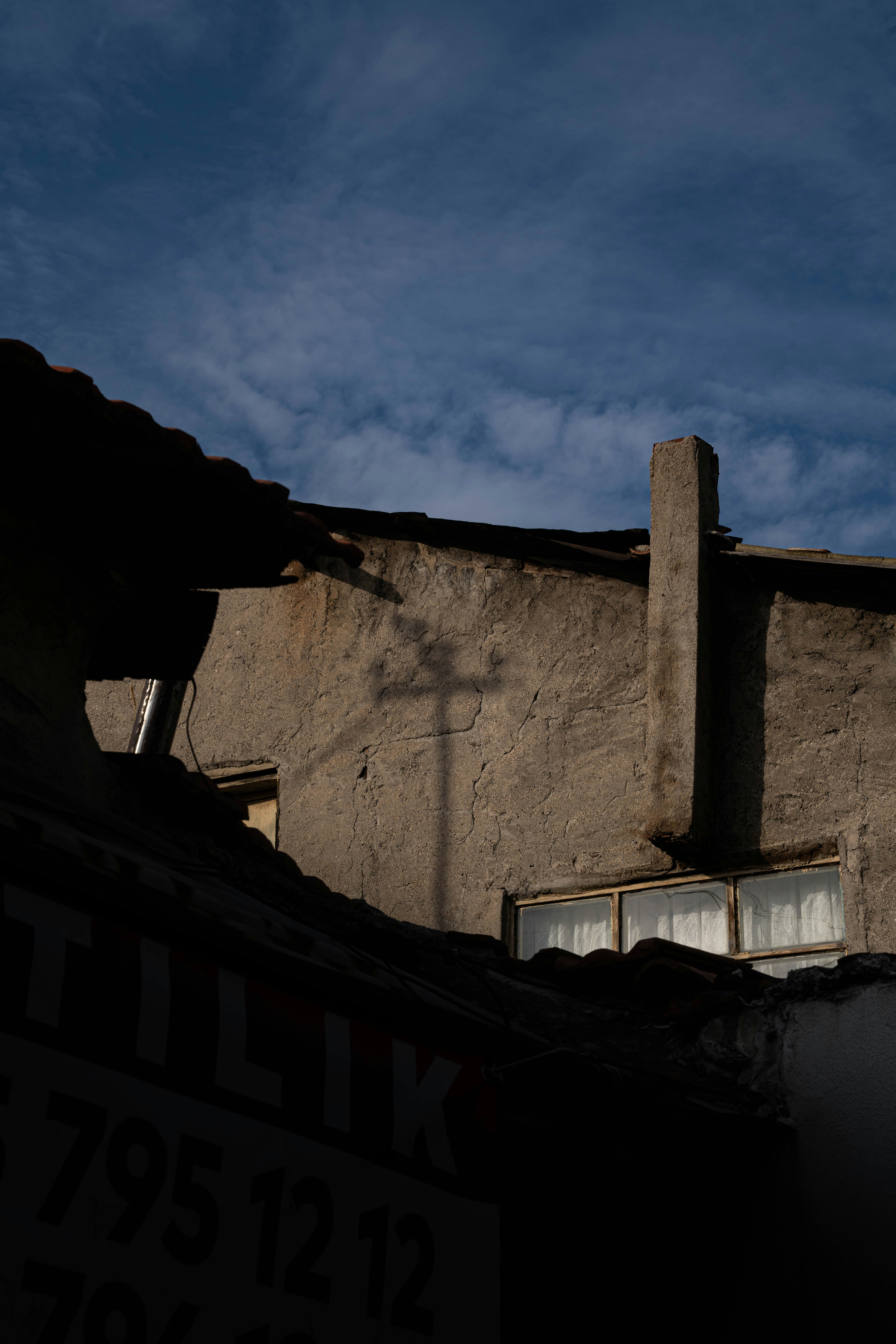 Shadowed Roofline Against a Blue Sky