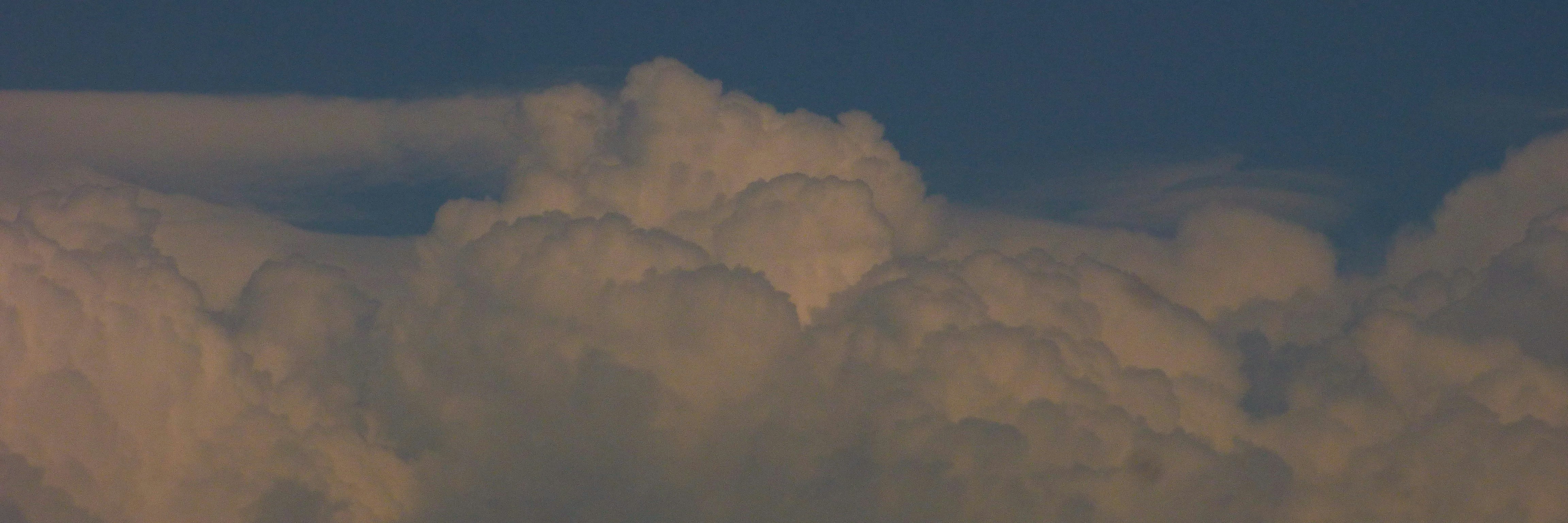 Sunlit Cloudscape: Soft Cumulus at Dusk