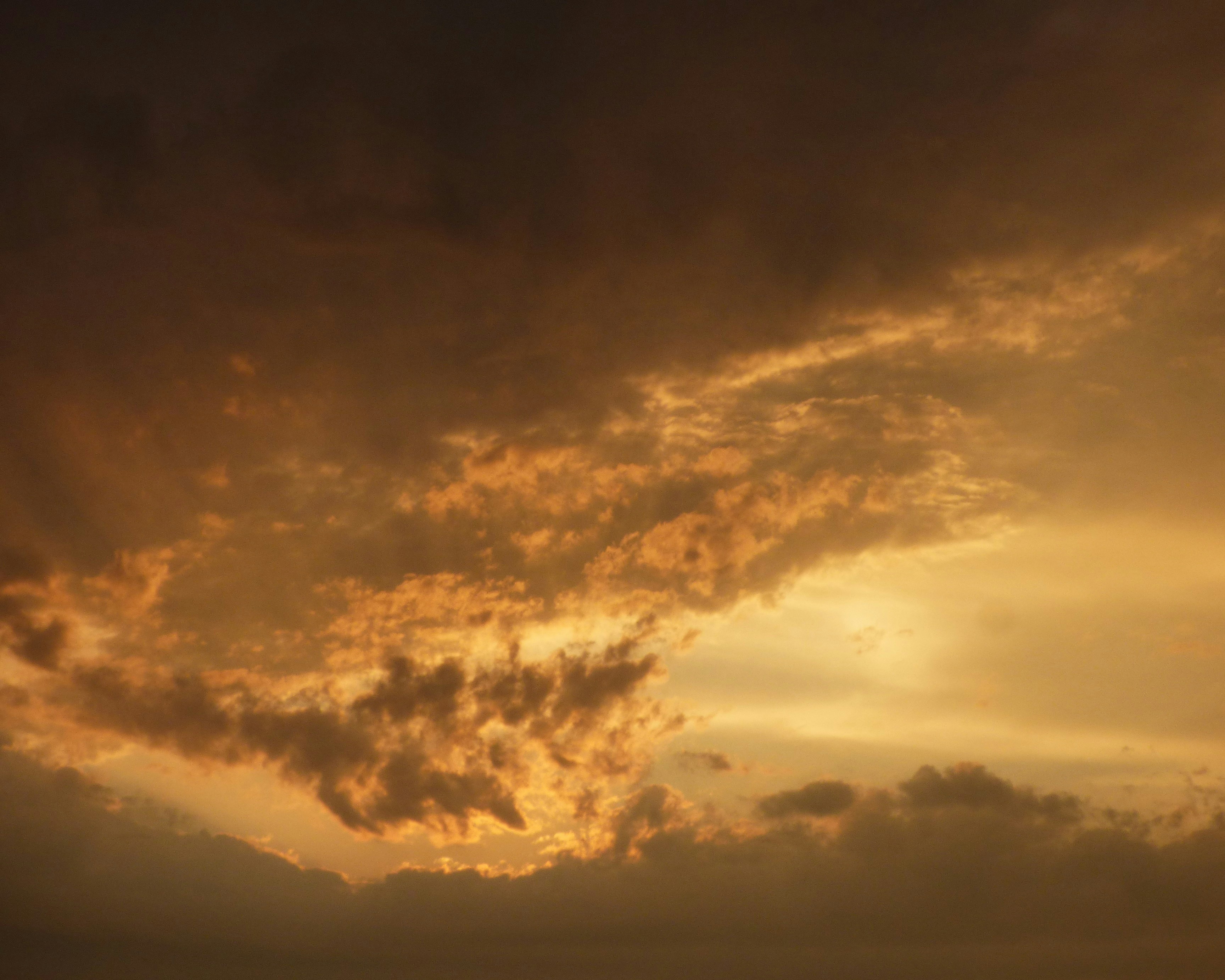 Golden Crest: A Skylit Break in Storm Clouds