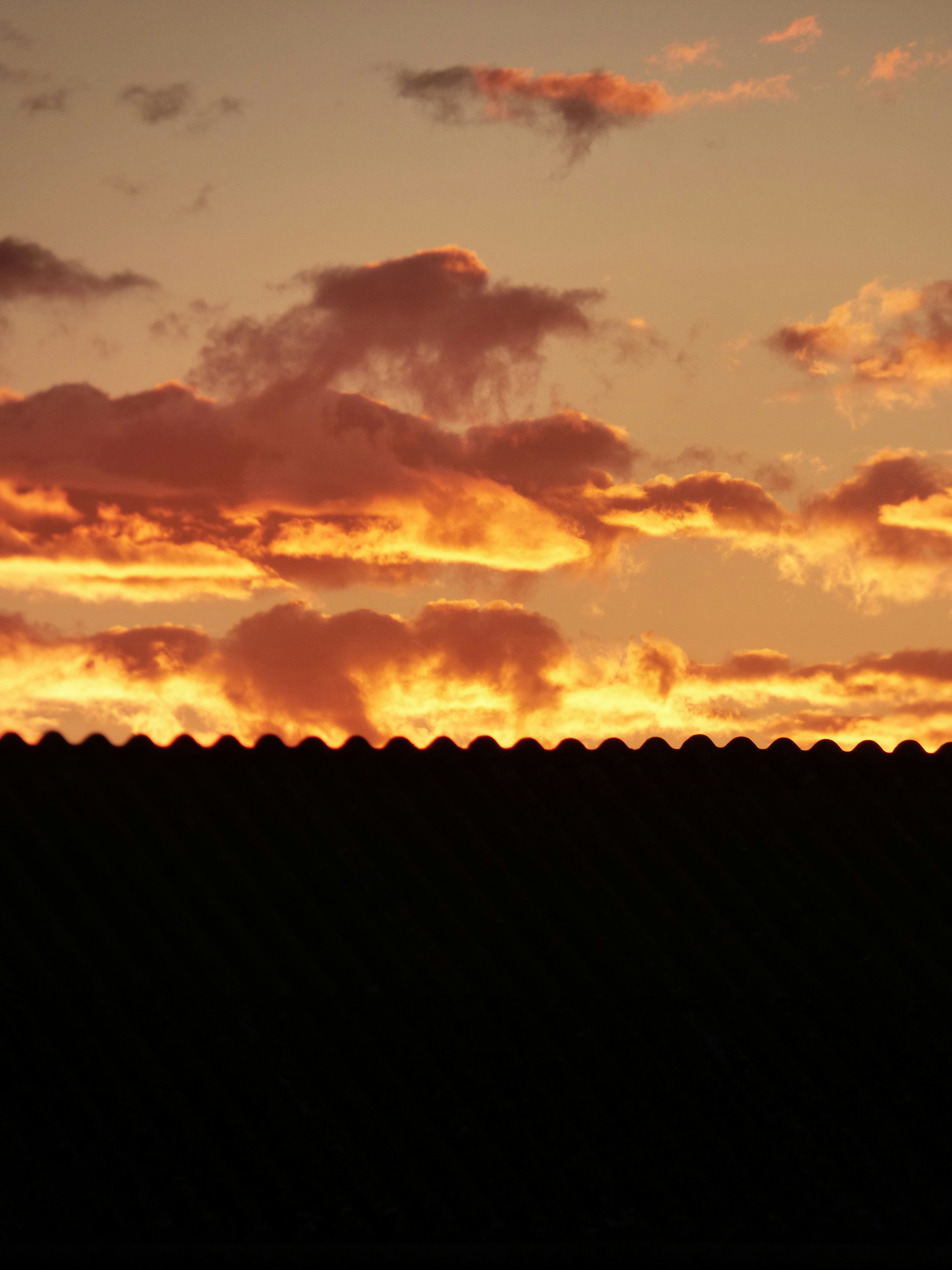 Sunset Silhouette over a Ridged Roof