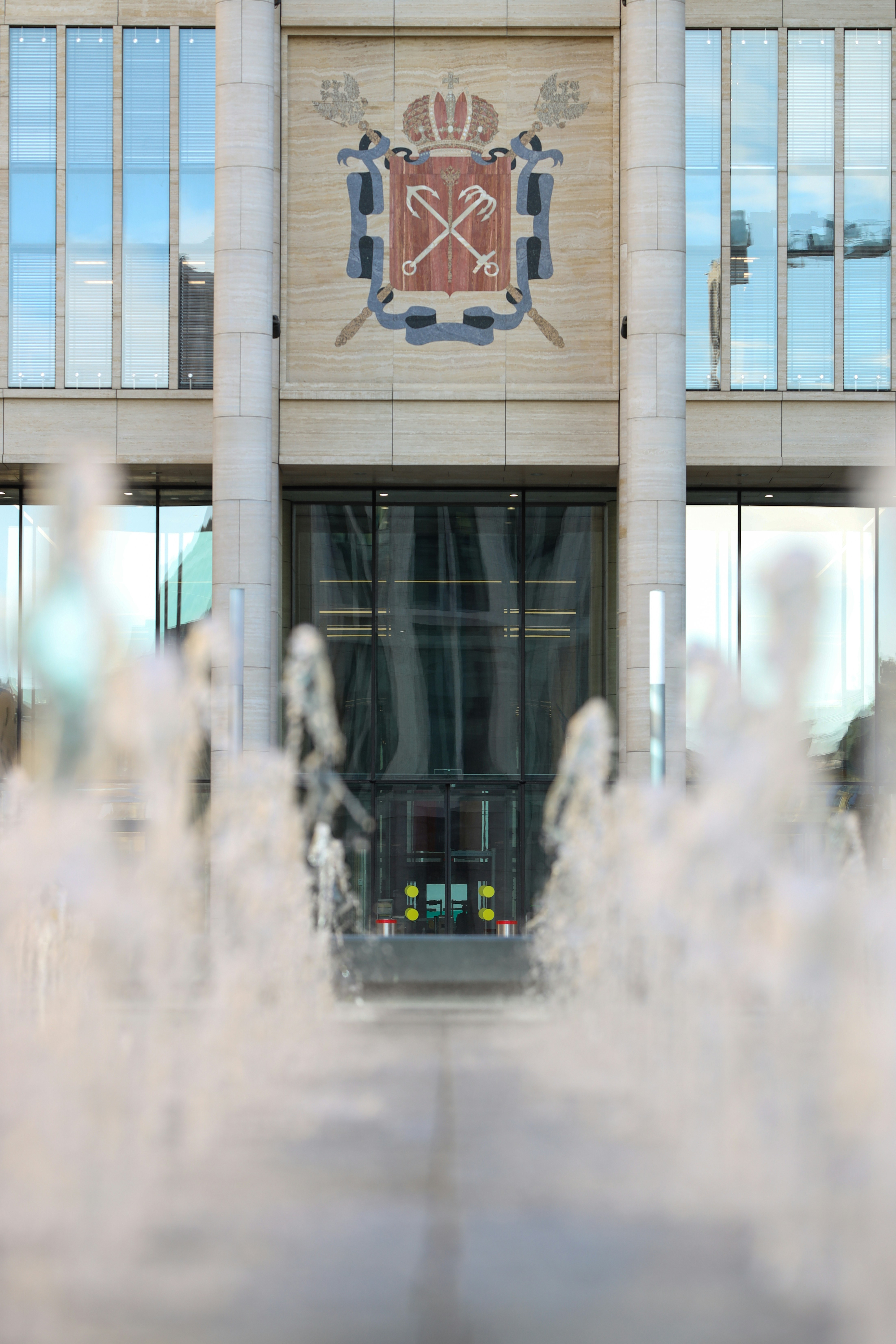 Coat of Arms Framed Entrance: Portrait of Authority Between Glass and Water