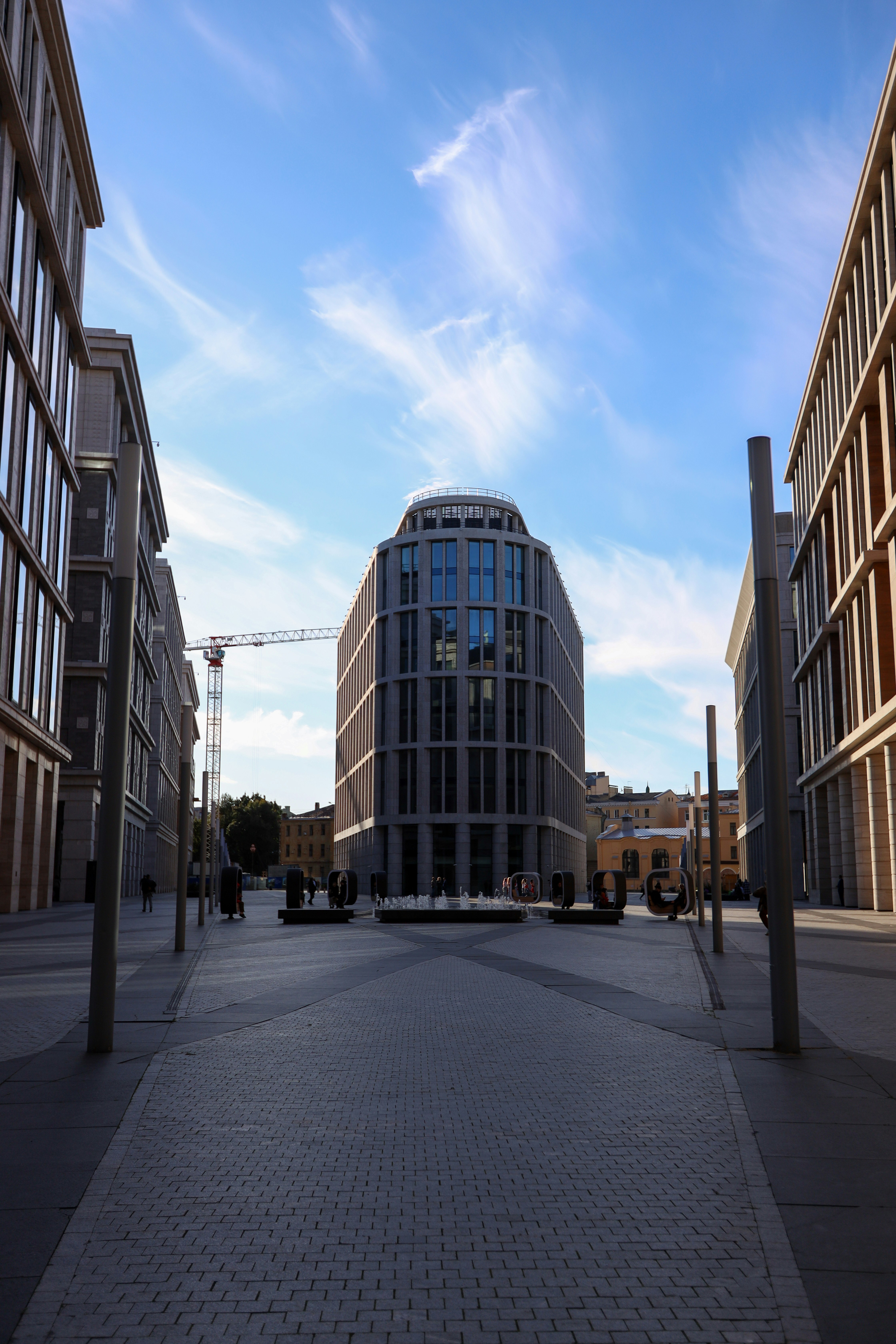 Symmetry and Sky: A City Atrium Framing a Modern Tower