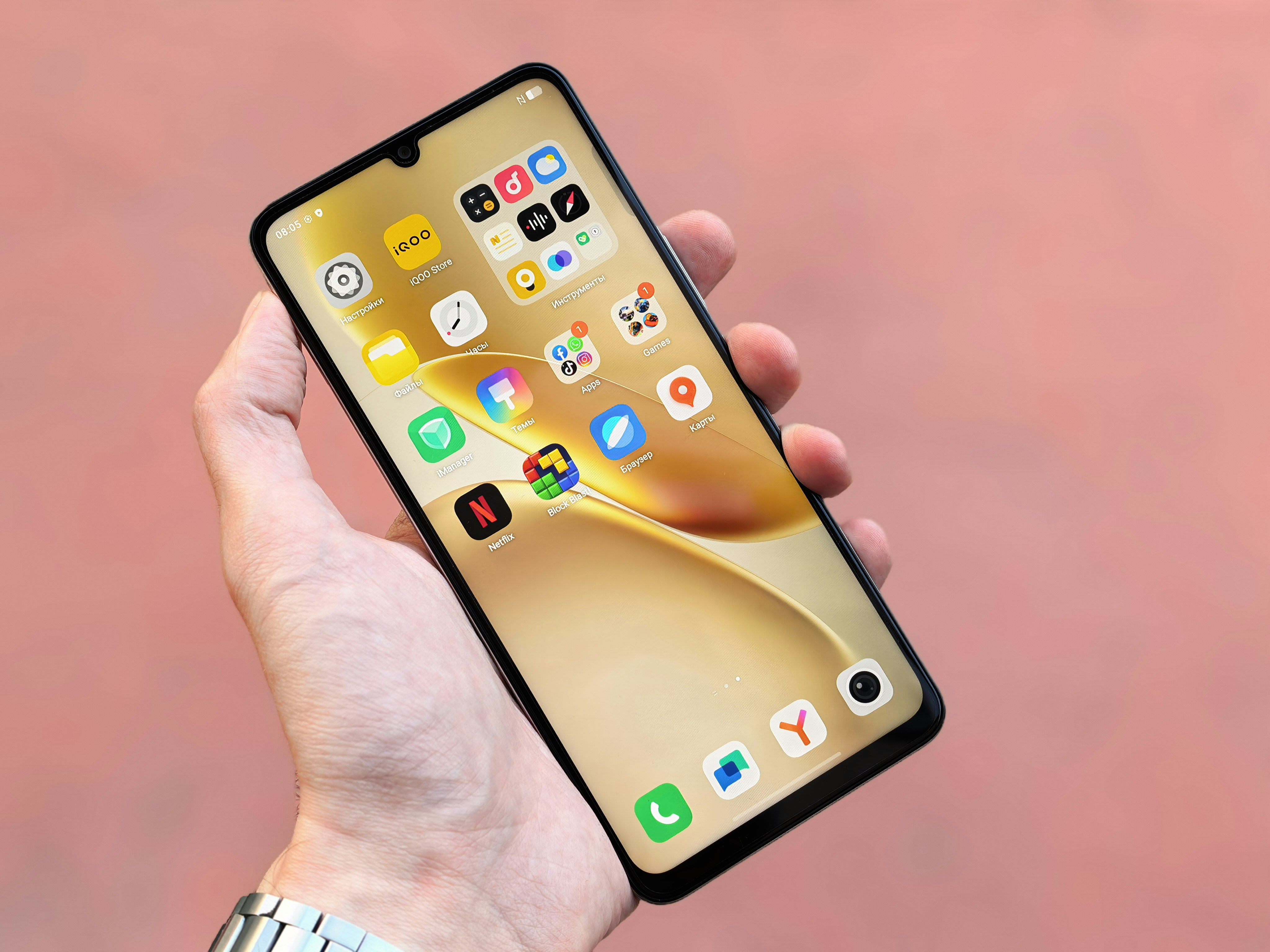 Gold-edged Screen in Hand: A Modern Portrait of a Sleek Smartphone Grasp