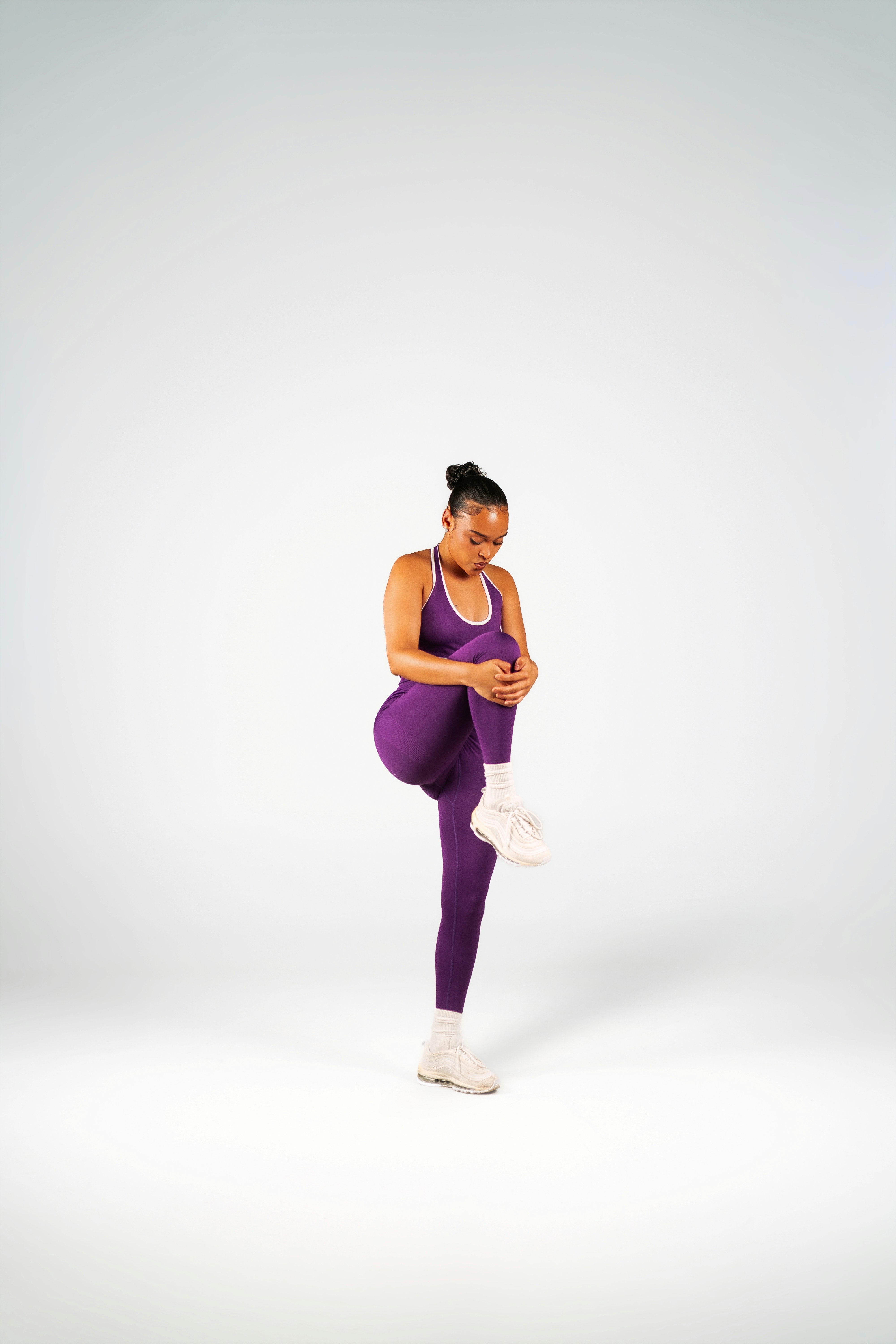 Elevated Balance: a dancer in purple forms a quiet pose
