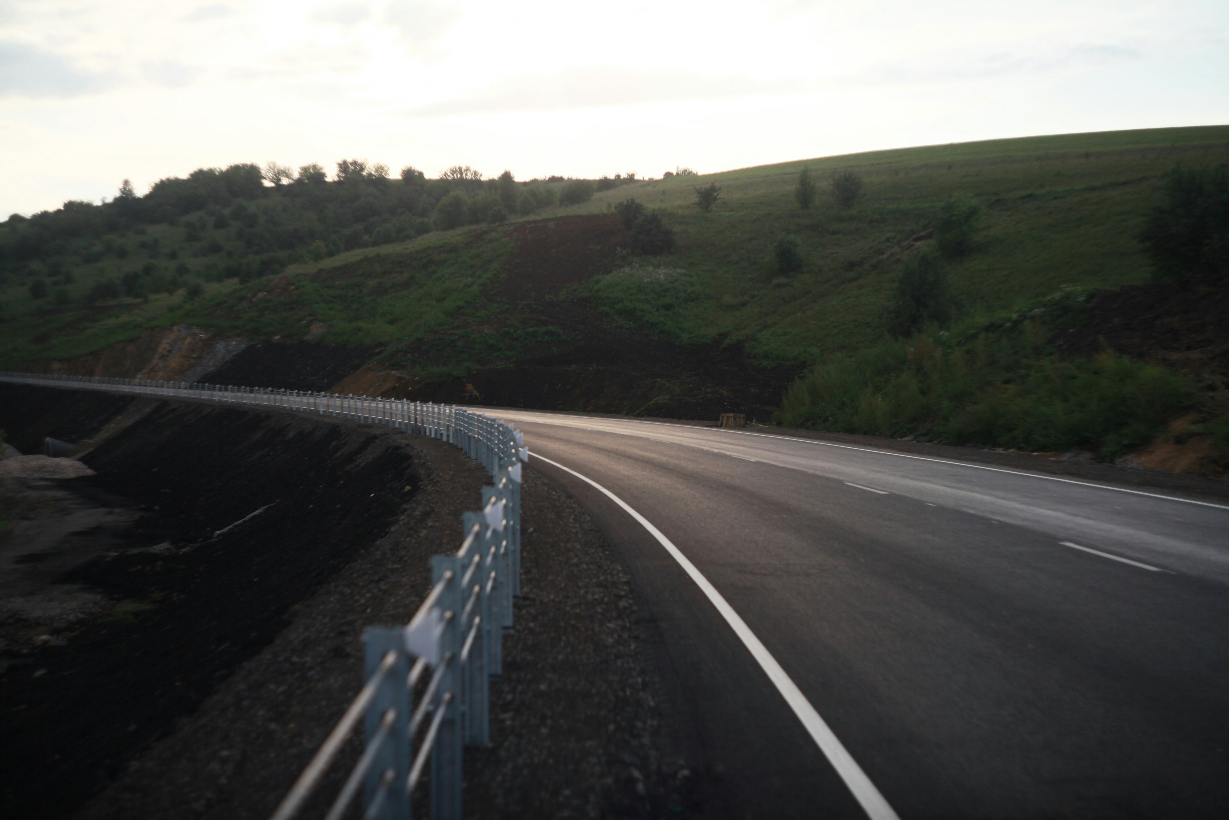 Curving Highway Bids Farewell to a Green Ridge