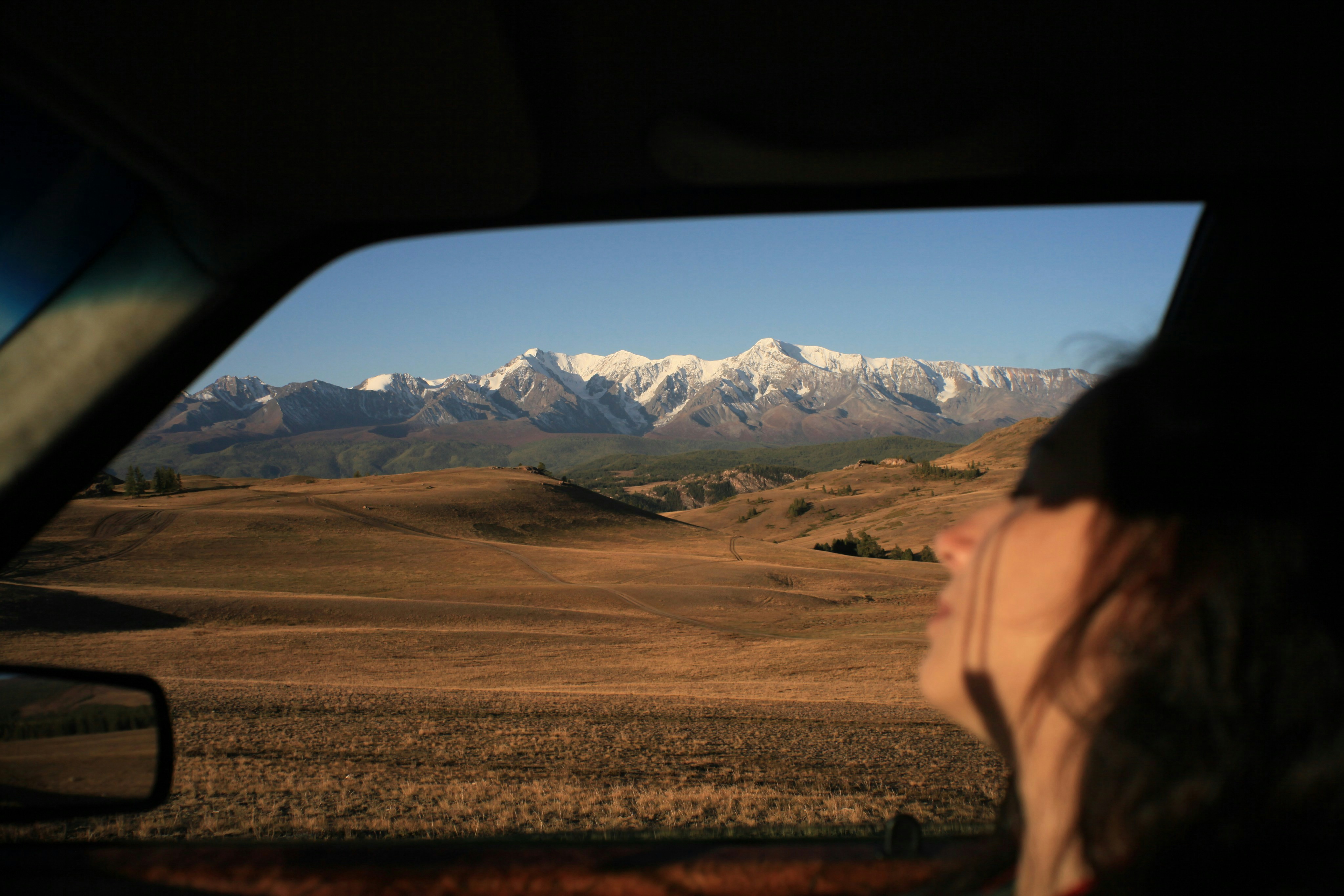 Rear-Seat Vista: Snow-Capped Peaks Through the Car Window