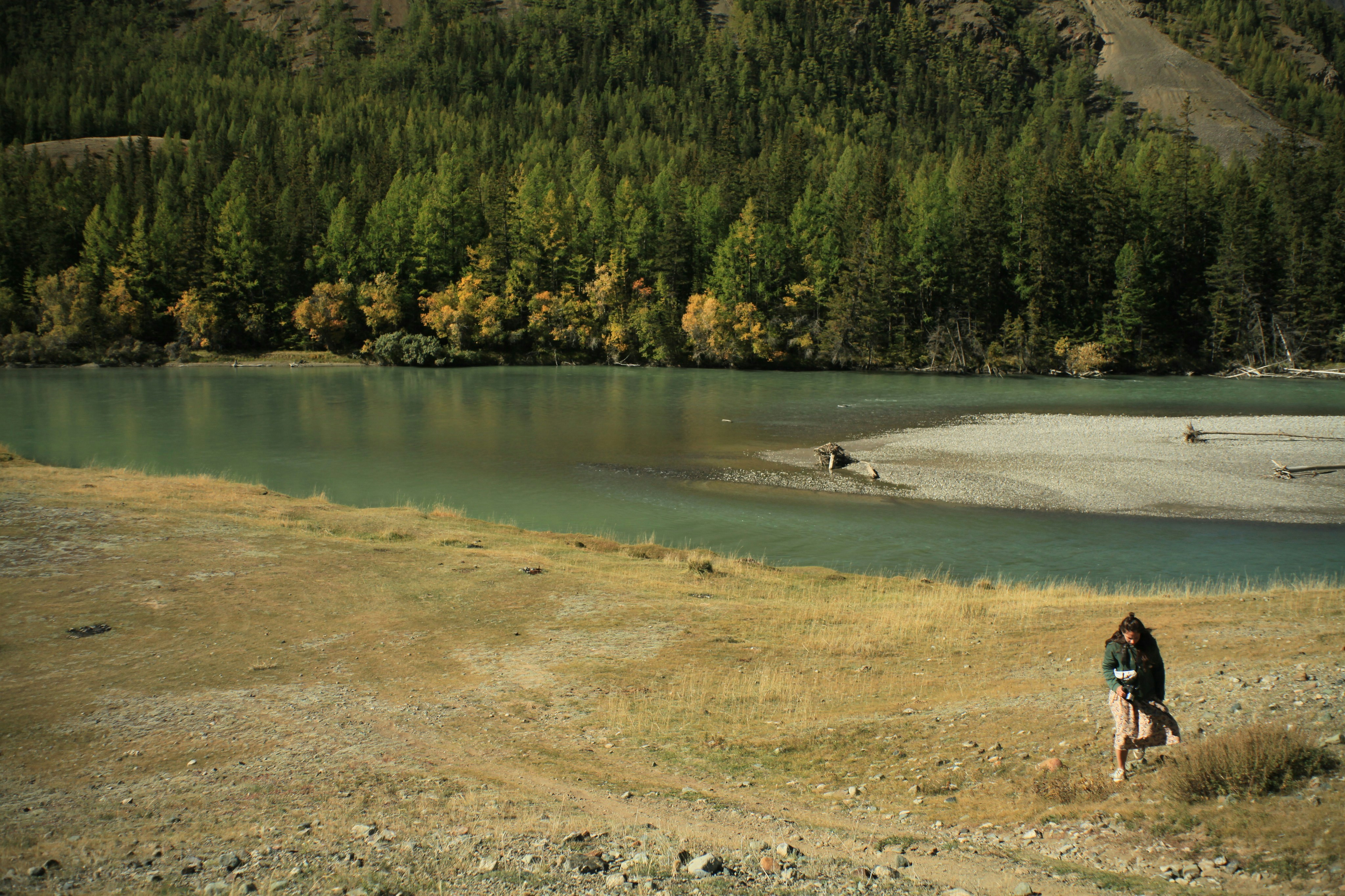 Hiker at the Edge: A Quiet Moment by the Turquoise Basin