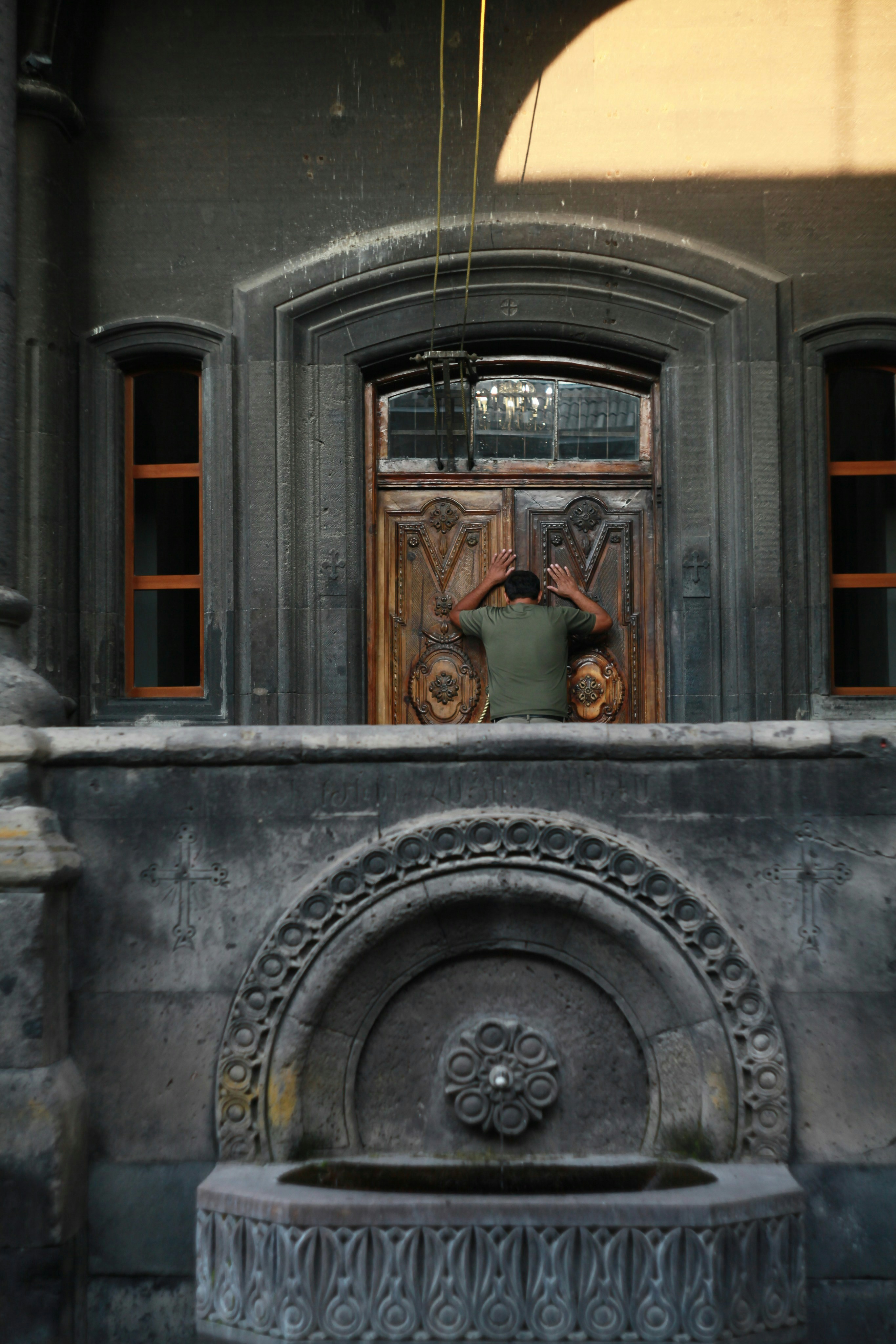 Doorway of Focus: A Man Presses into an Ornate Portal