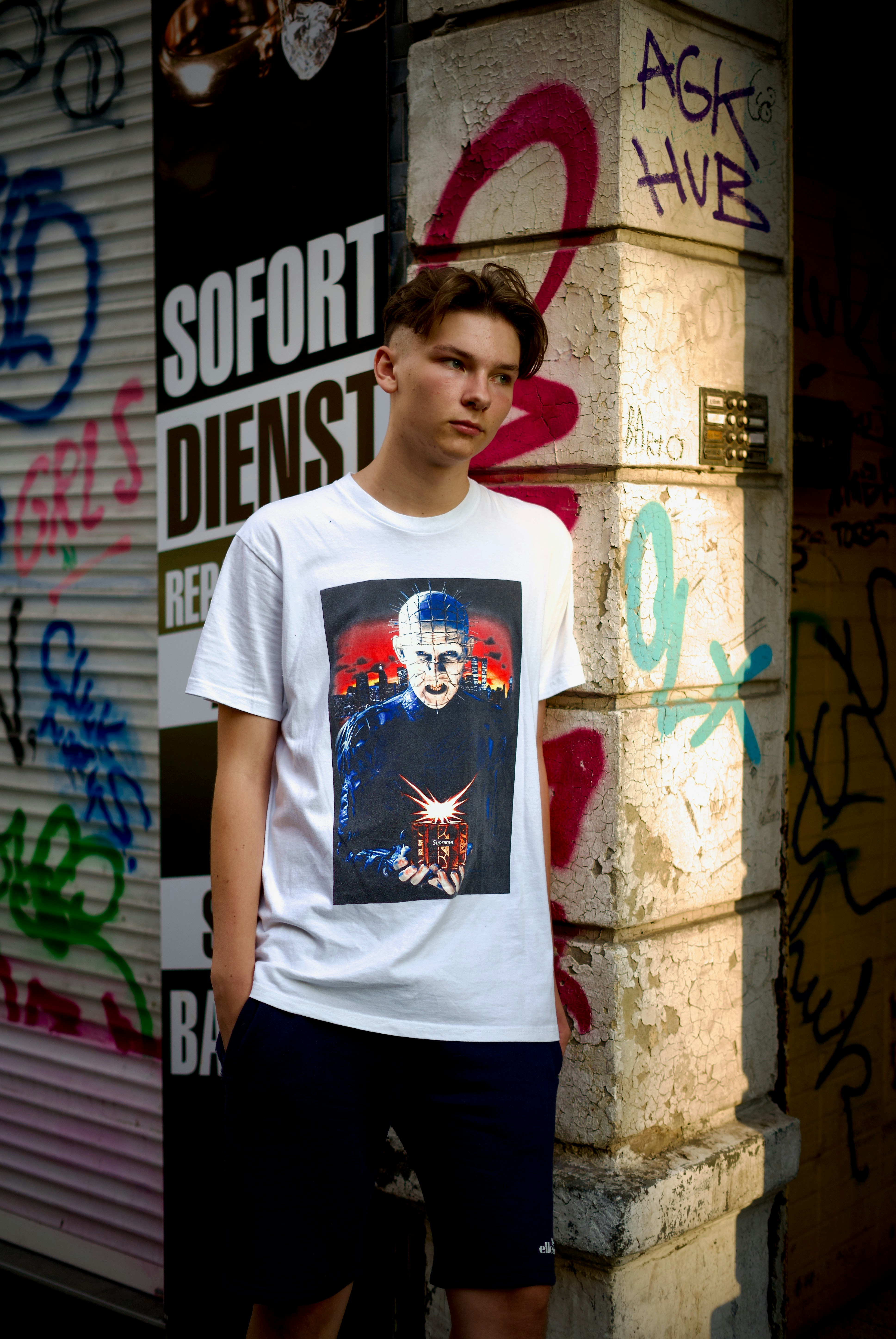 Portrait in a Graffitied Alley: Youthful Quiet Amid Neon Graffiti
