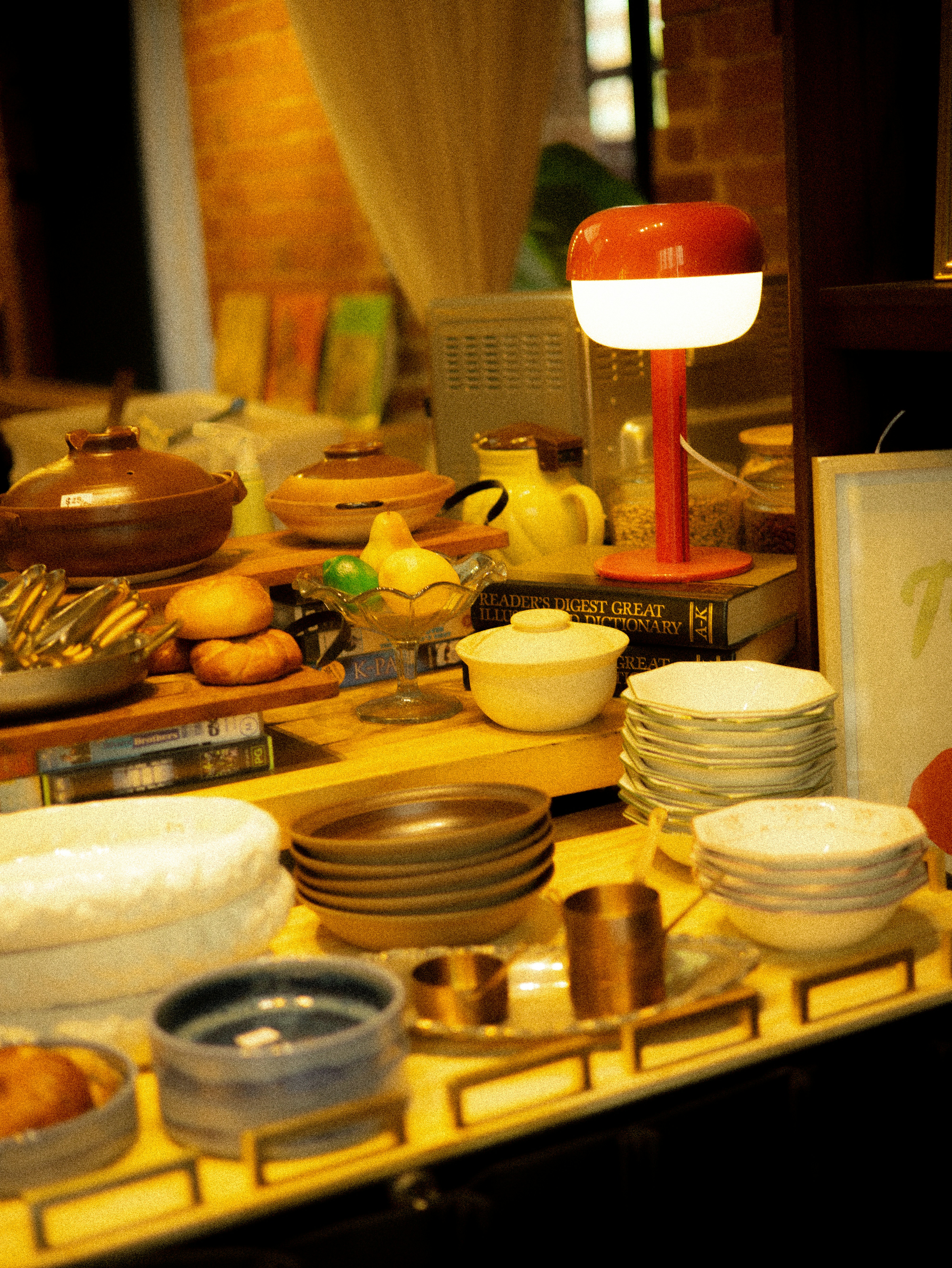 Warm Night-Shift Bakery Display Under a Red-Top Lamp