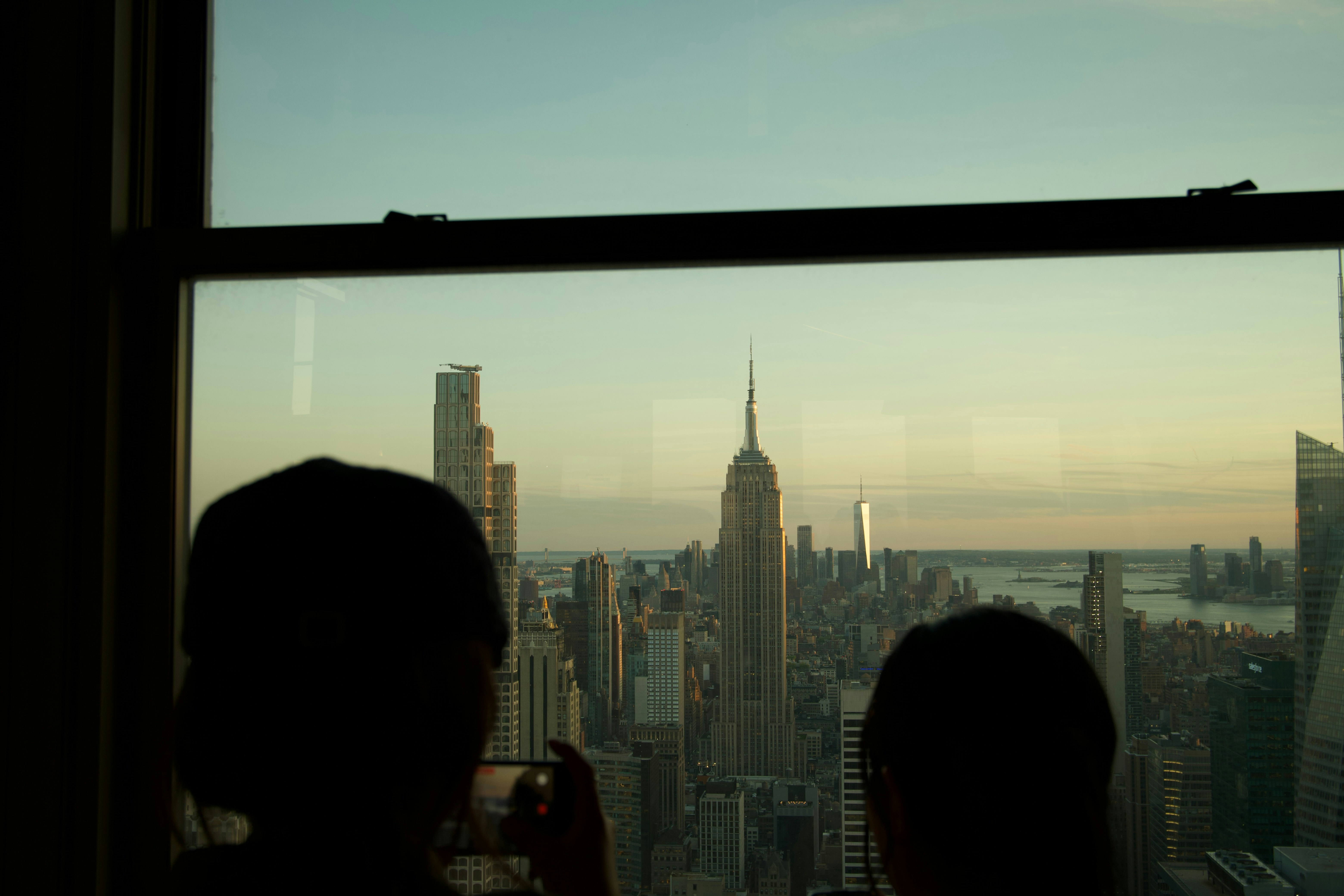 Cityscape Gaze: Silhouettes Framing the Empire State View