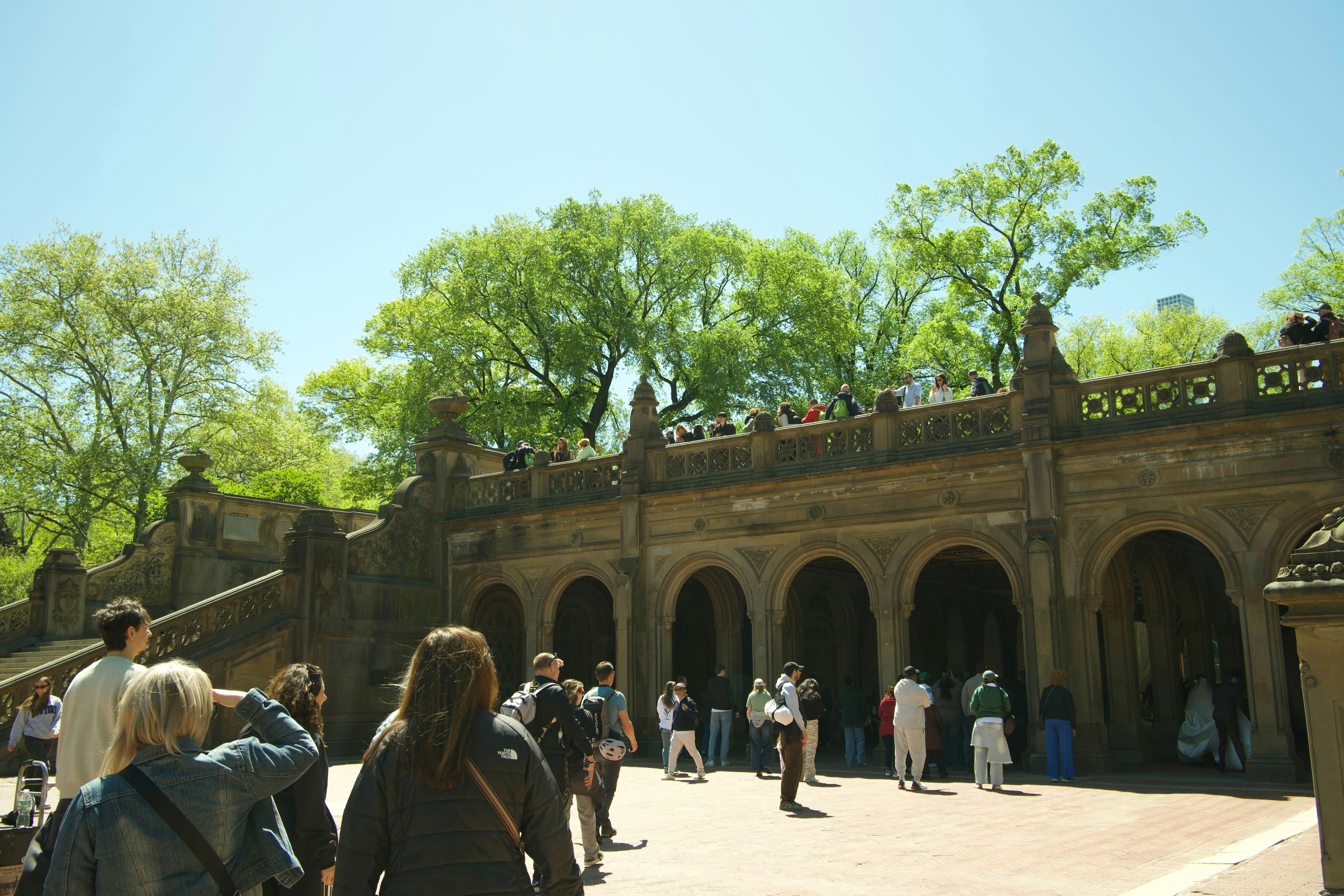 Crowd at a Sunlit Terraced Arcade