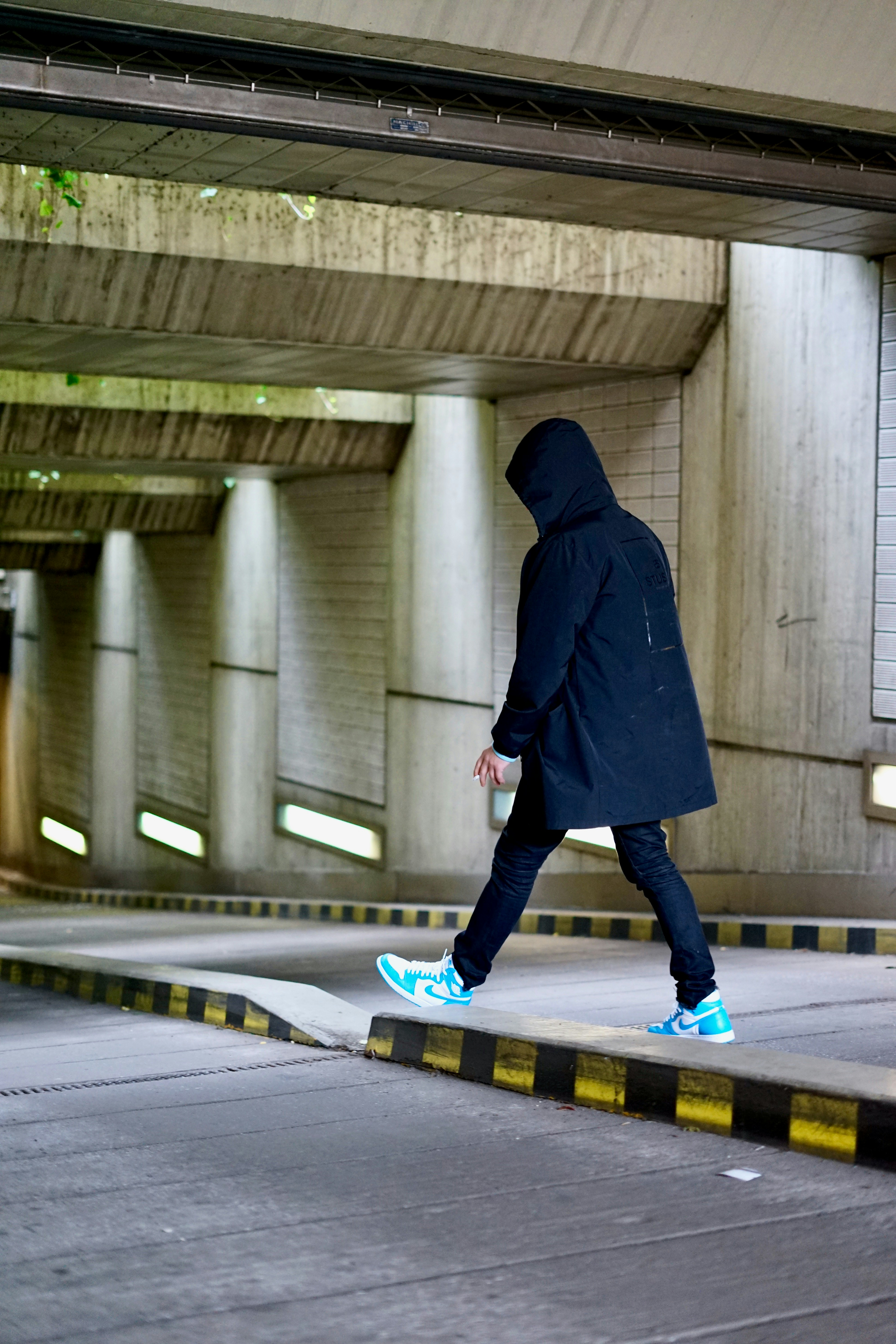 Silhouetted Runner in an Urban Concrete Corridor