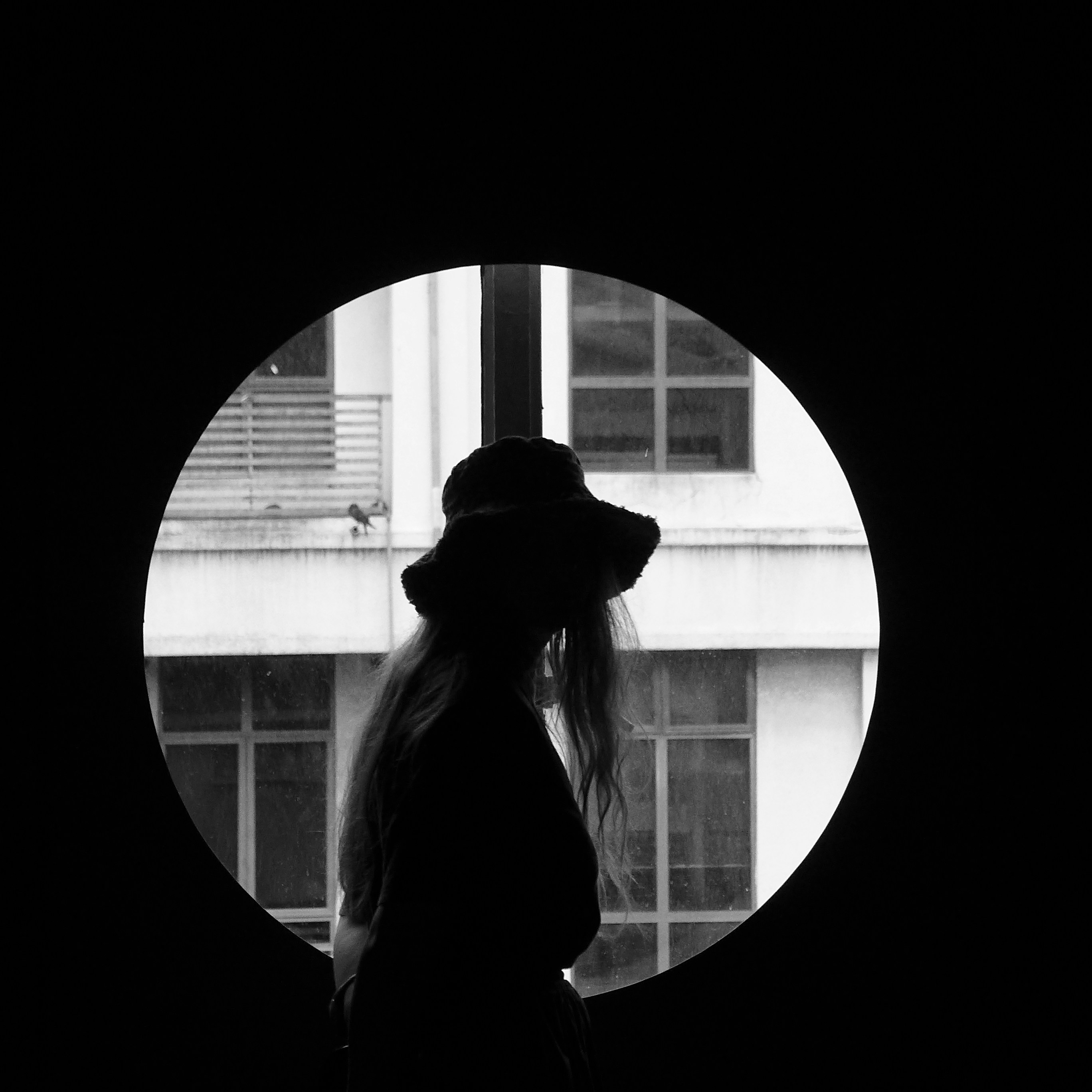 Silhouette in a Circular Window Cutout