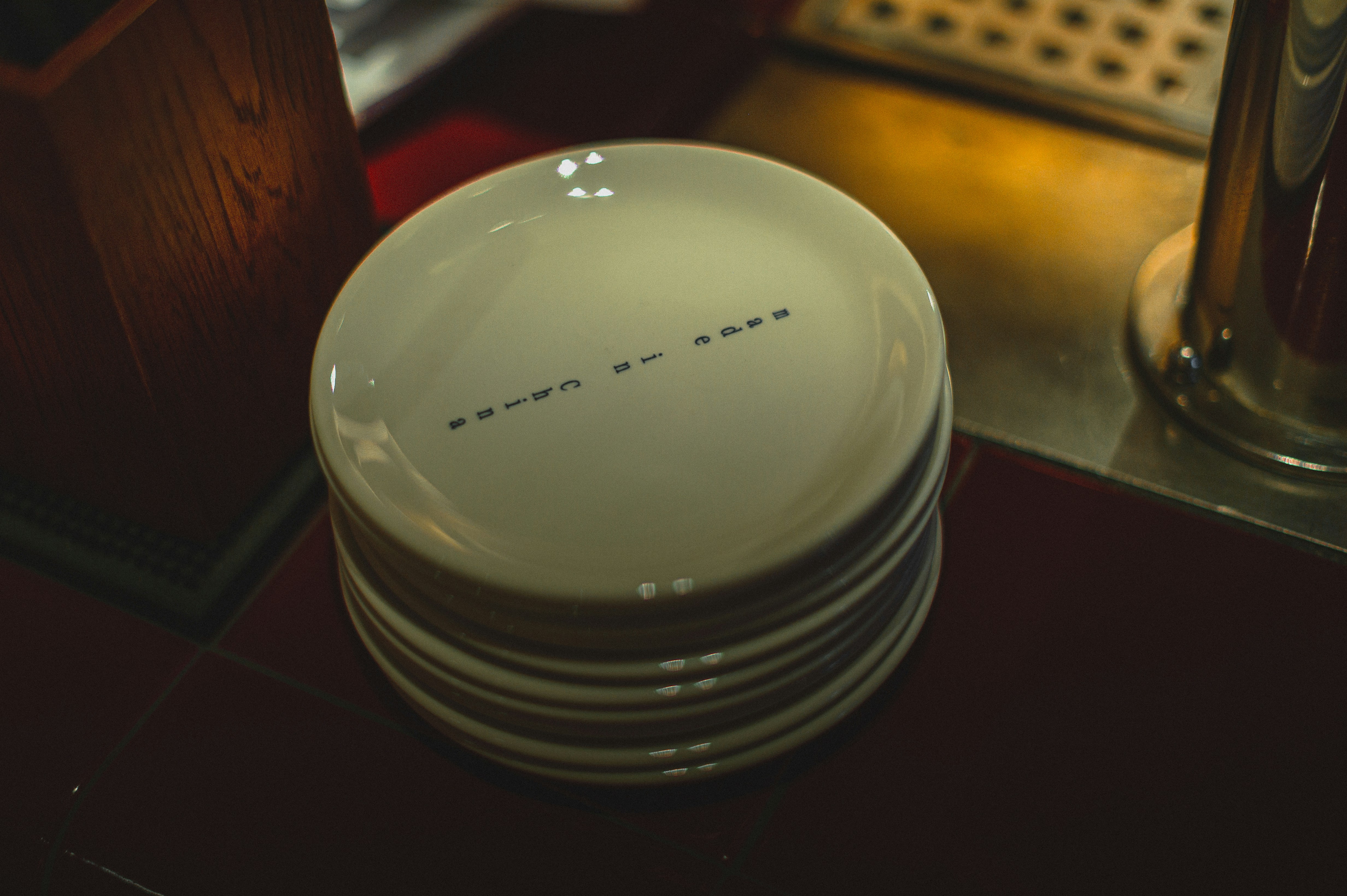 Stacked Diner Dishes Under Warm Café Light