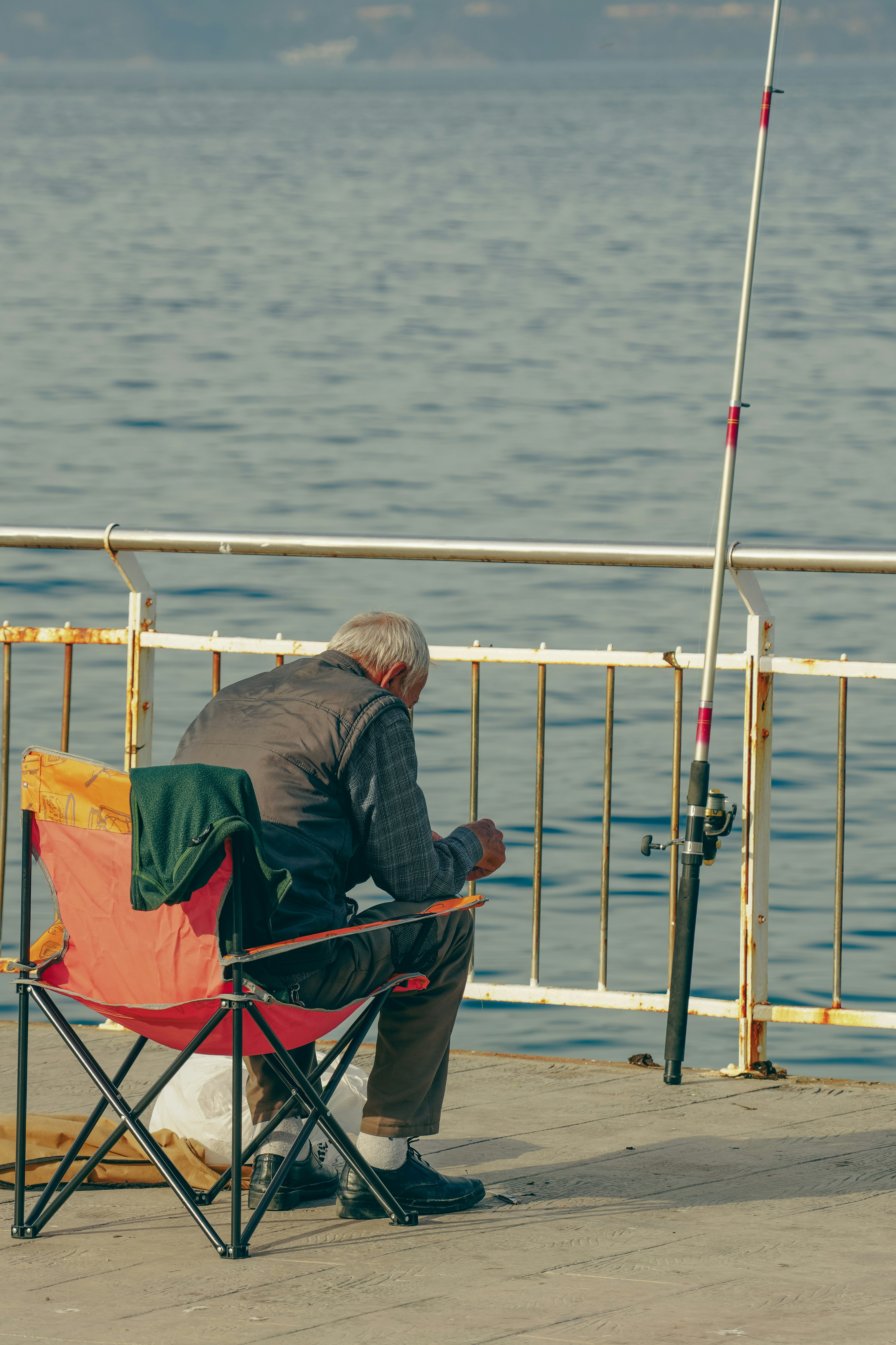Lonely Line by the Lake: An Elder Angler in Quiet Focus
