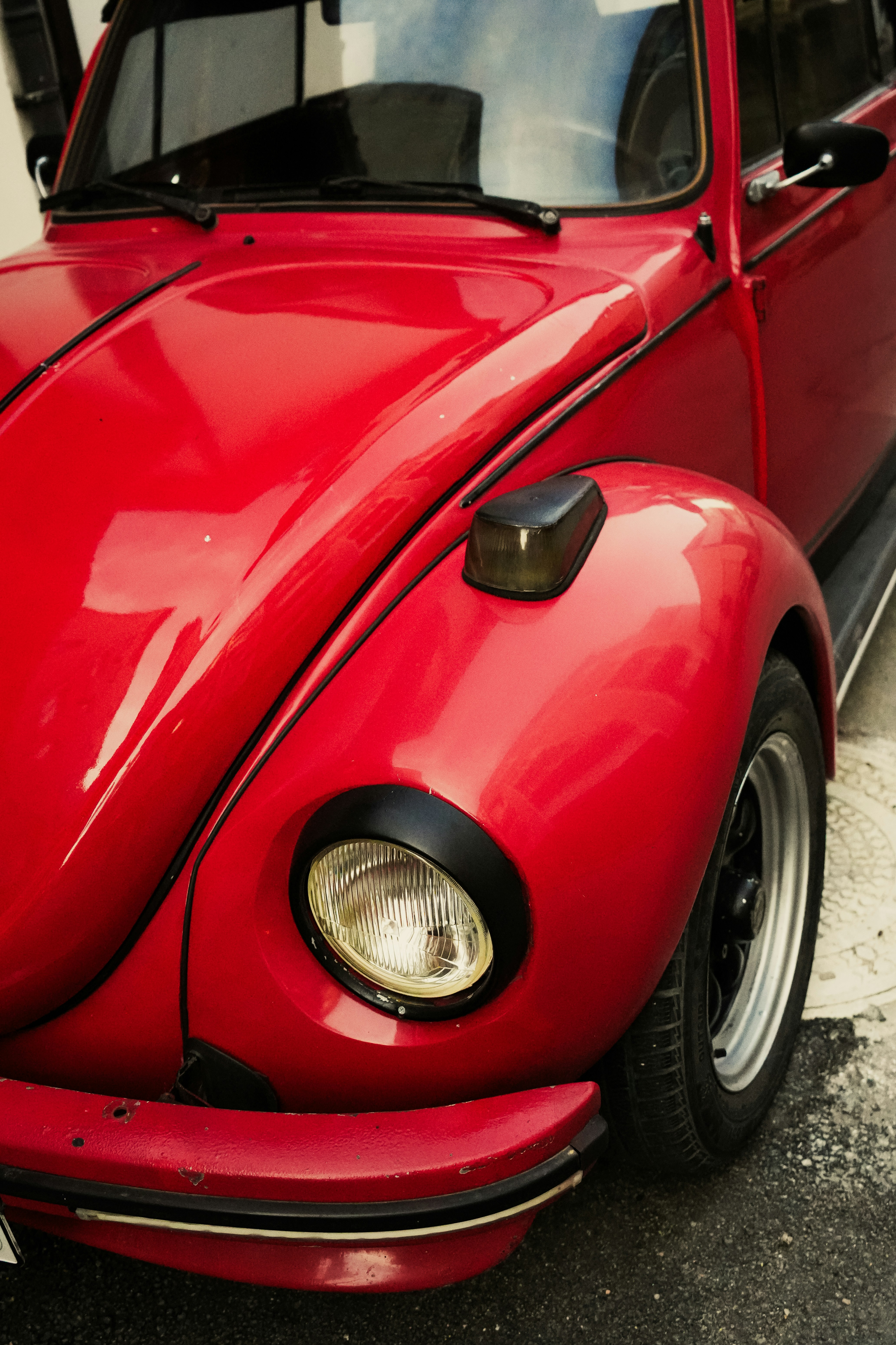 Crimson Classic: Close-Up Of A Beetle-Red VW Headlamp