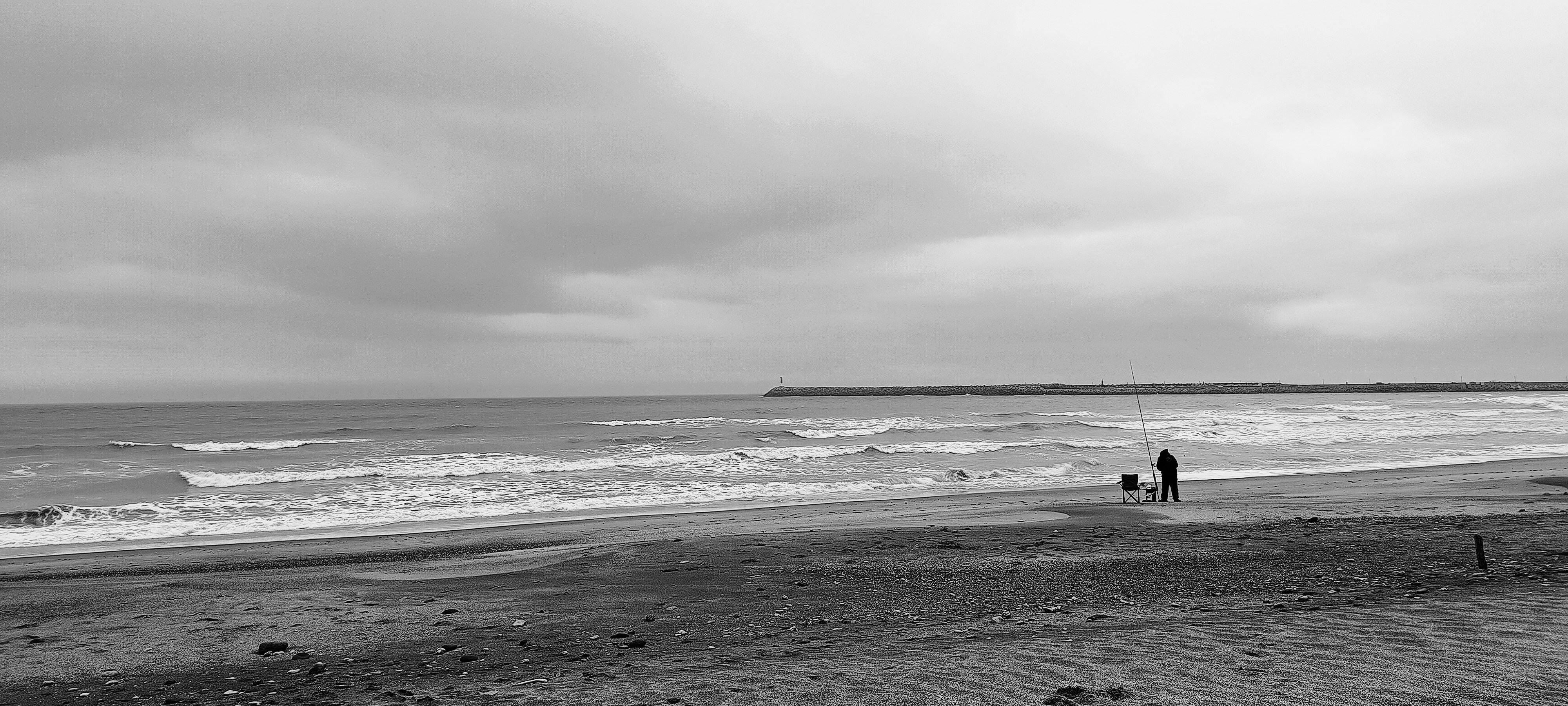 Two Figures at the Edge: A Quiet Seascape in Grey