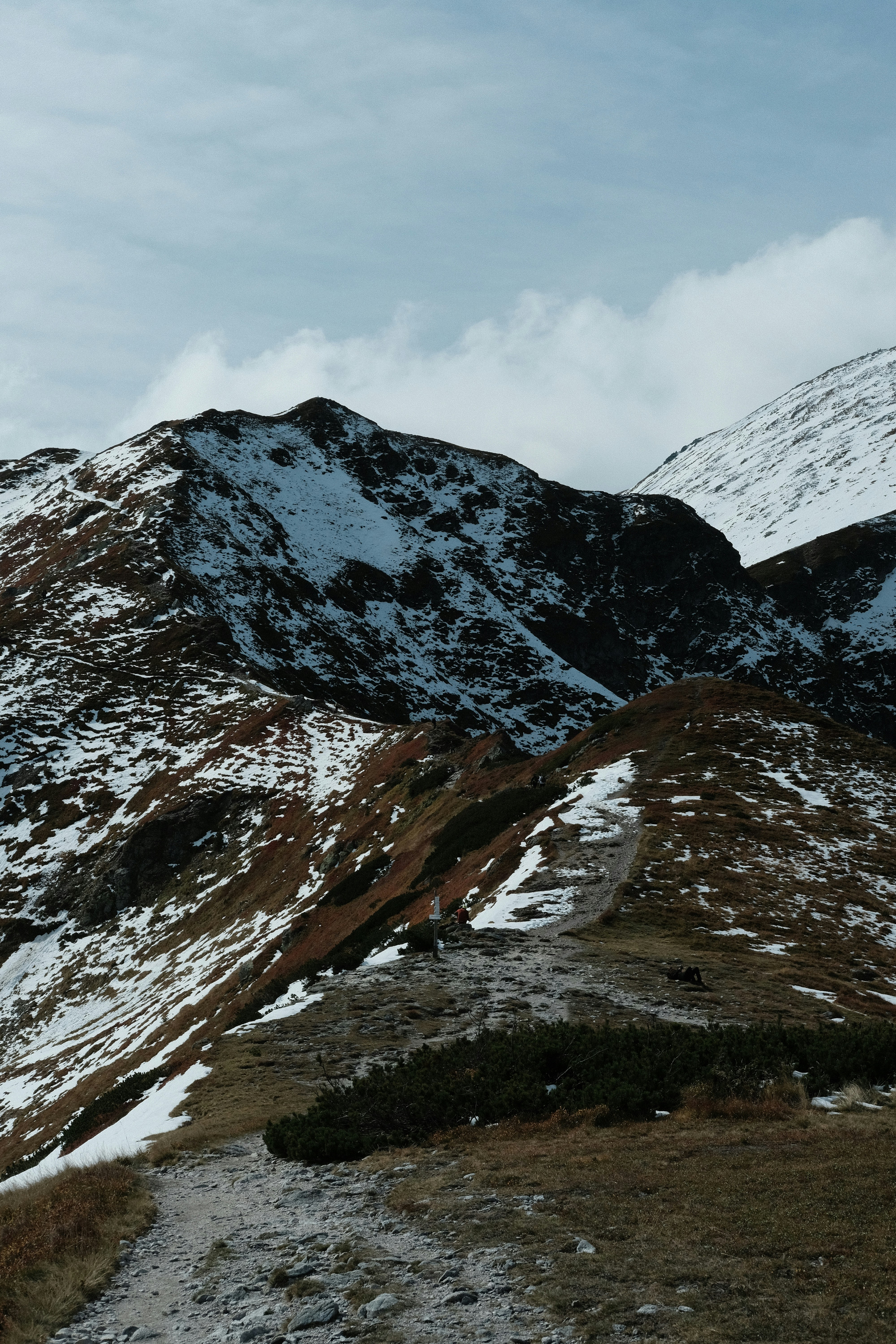 Snow-kissed Ridge Atop a Winding Alpine Trail