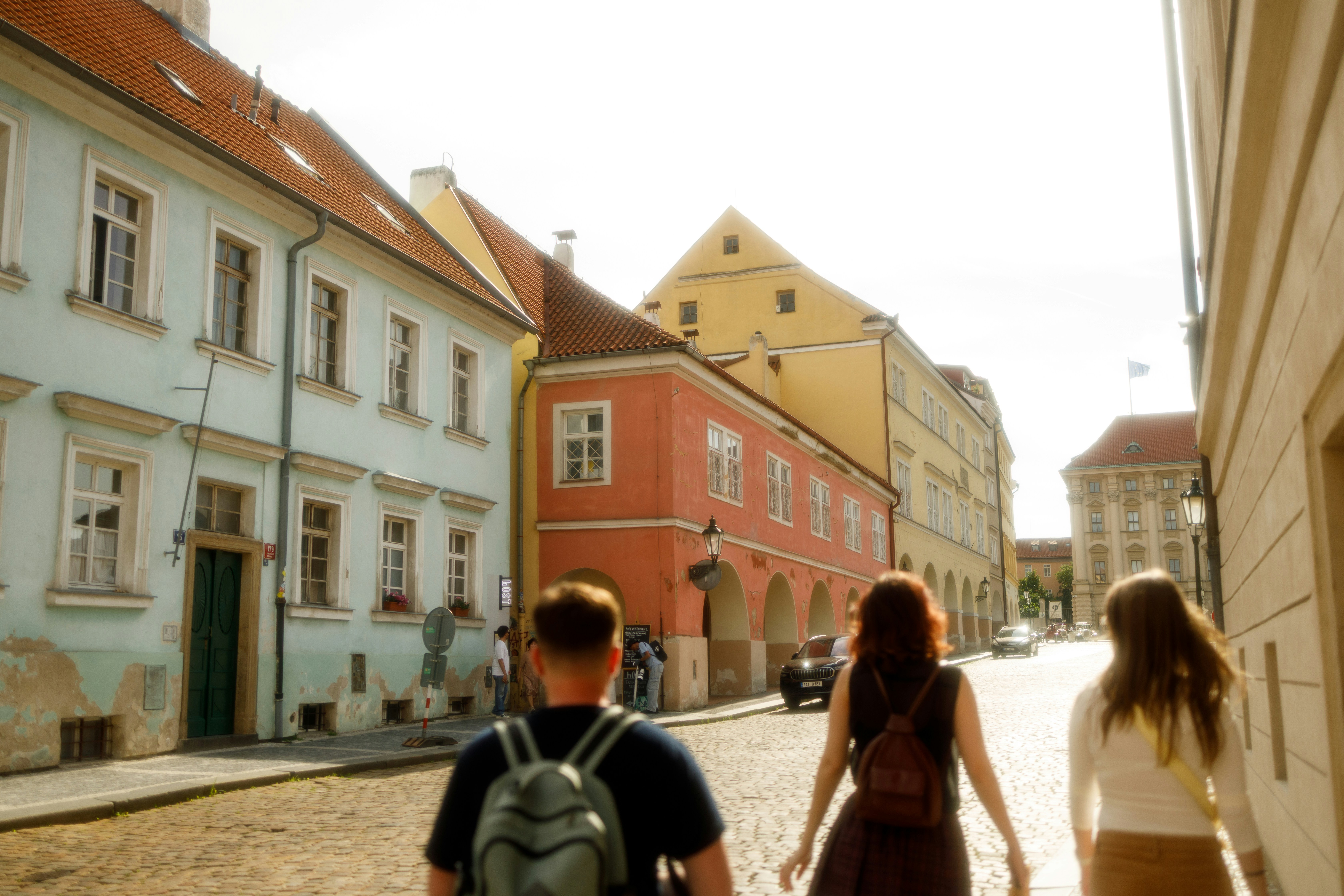 Pastel Facades on a Sunlit Cobblestone Street
