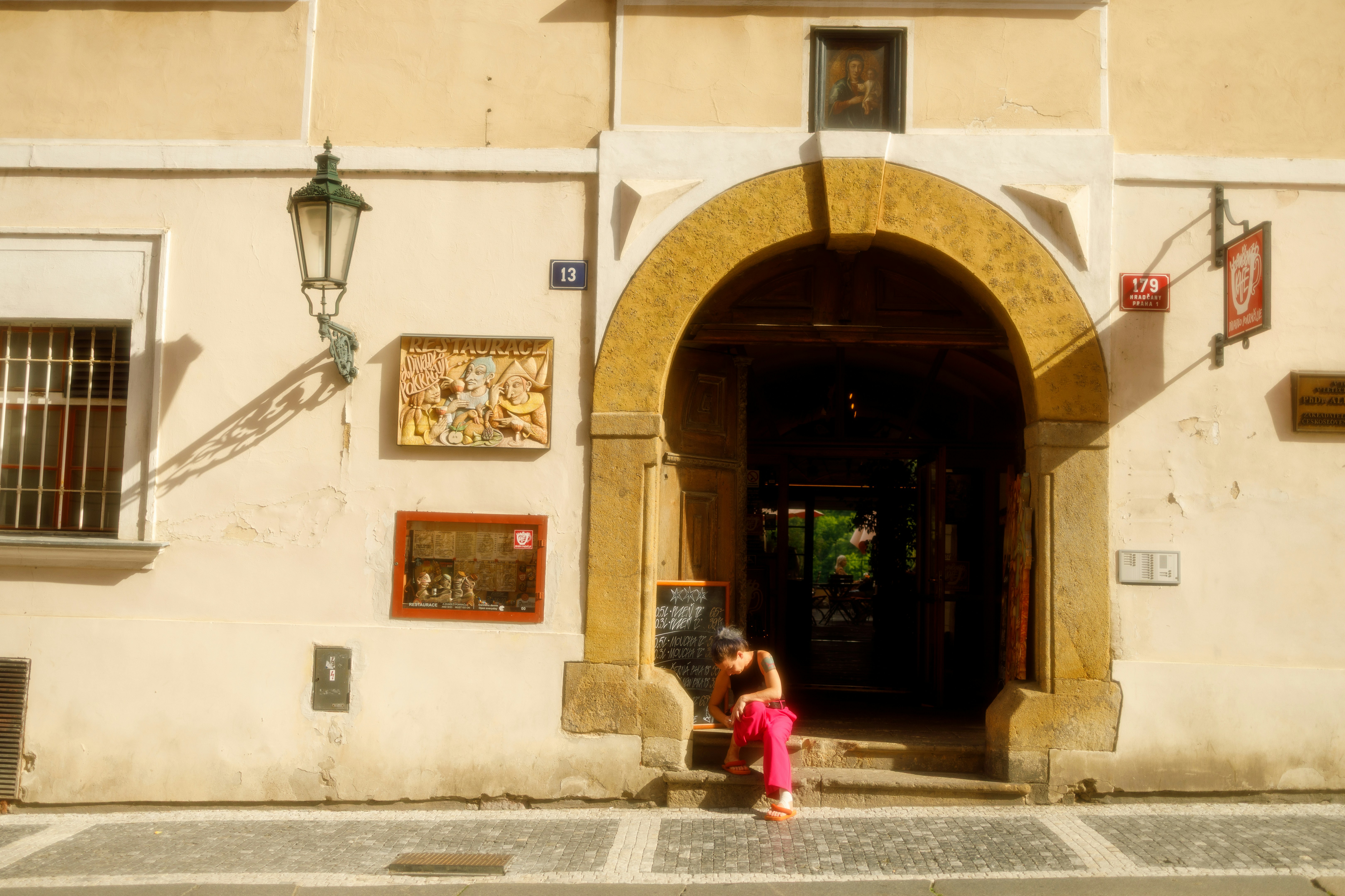 Sunlit Archway Portrait: a Quiet Moment by the Gate