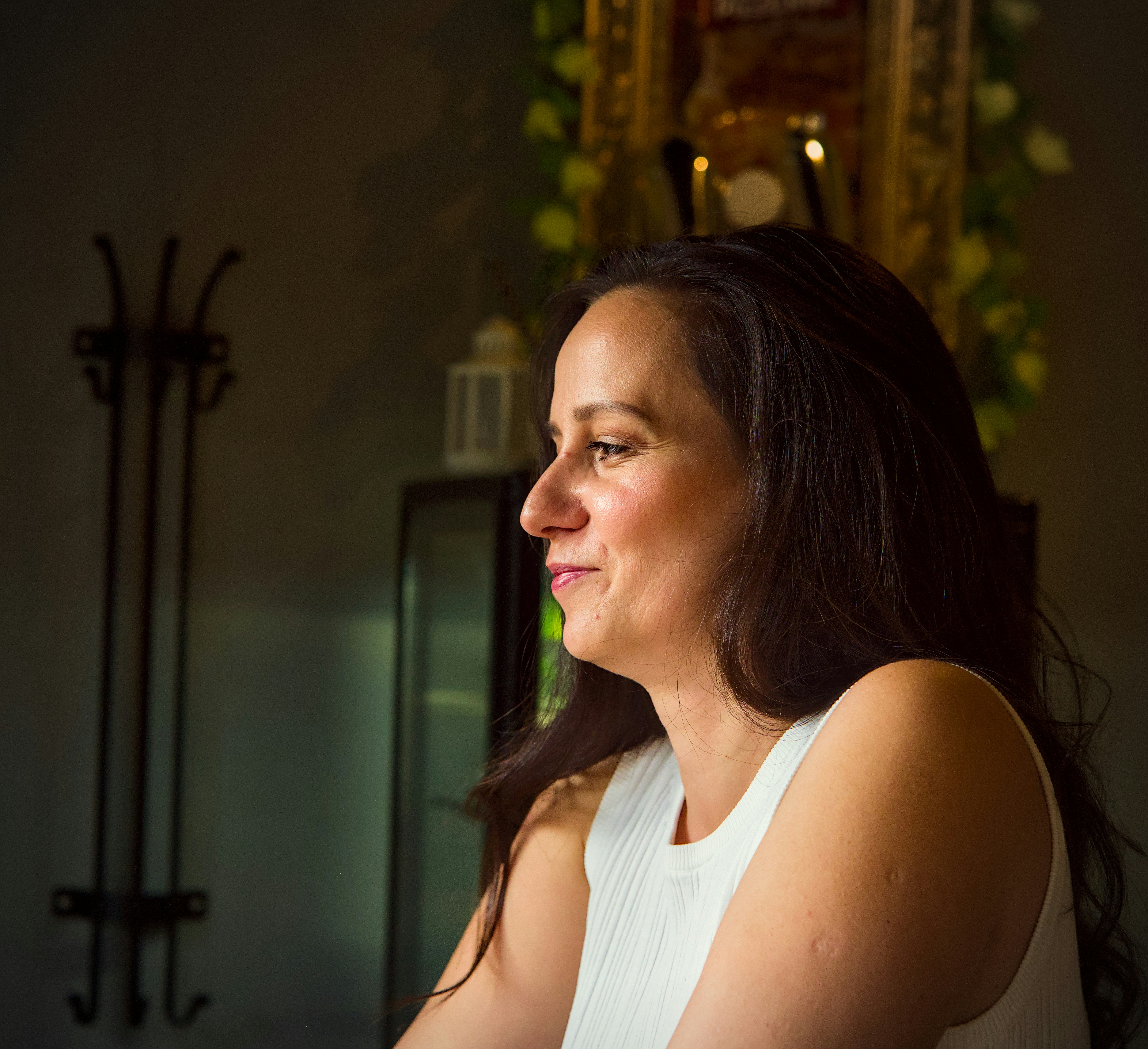 Portrait in Soft Spotlight: A Calm Moment with a White‑Sleeved Smile