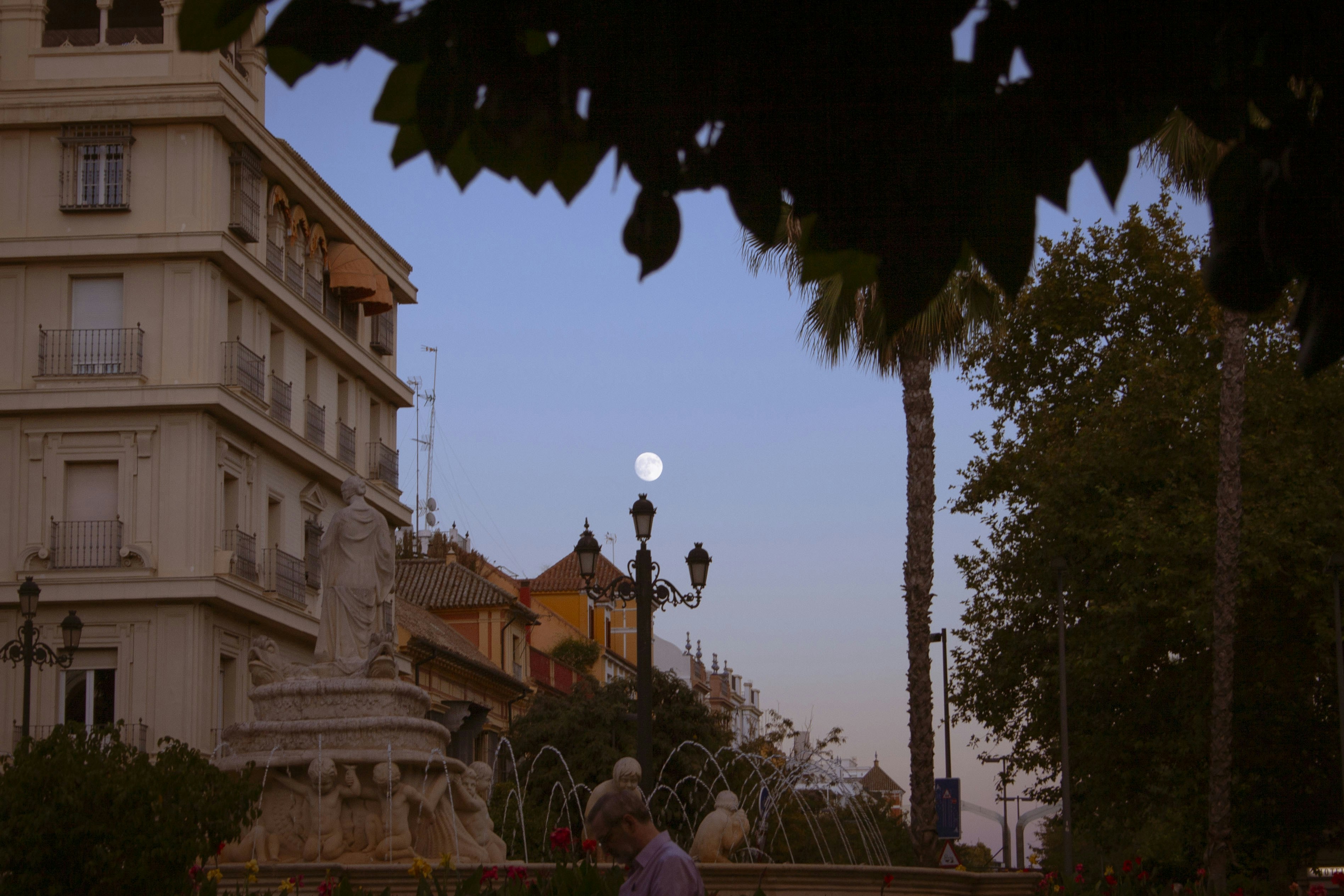 Moon over the Square: A Moment Above the Fountain