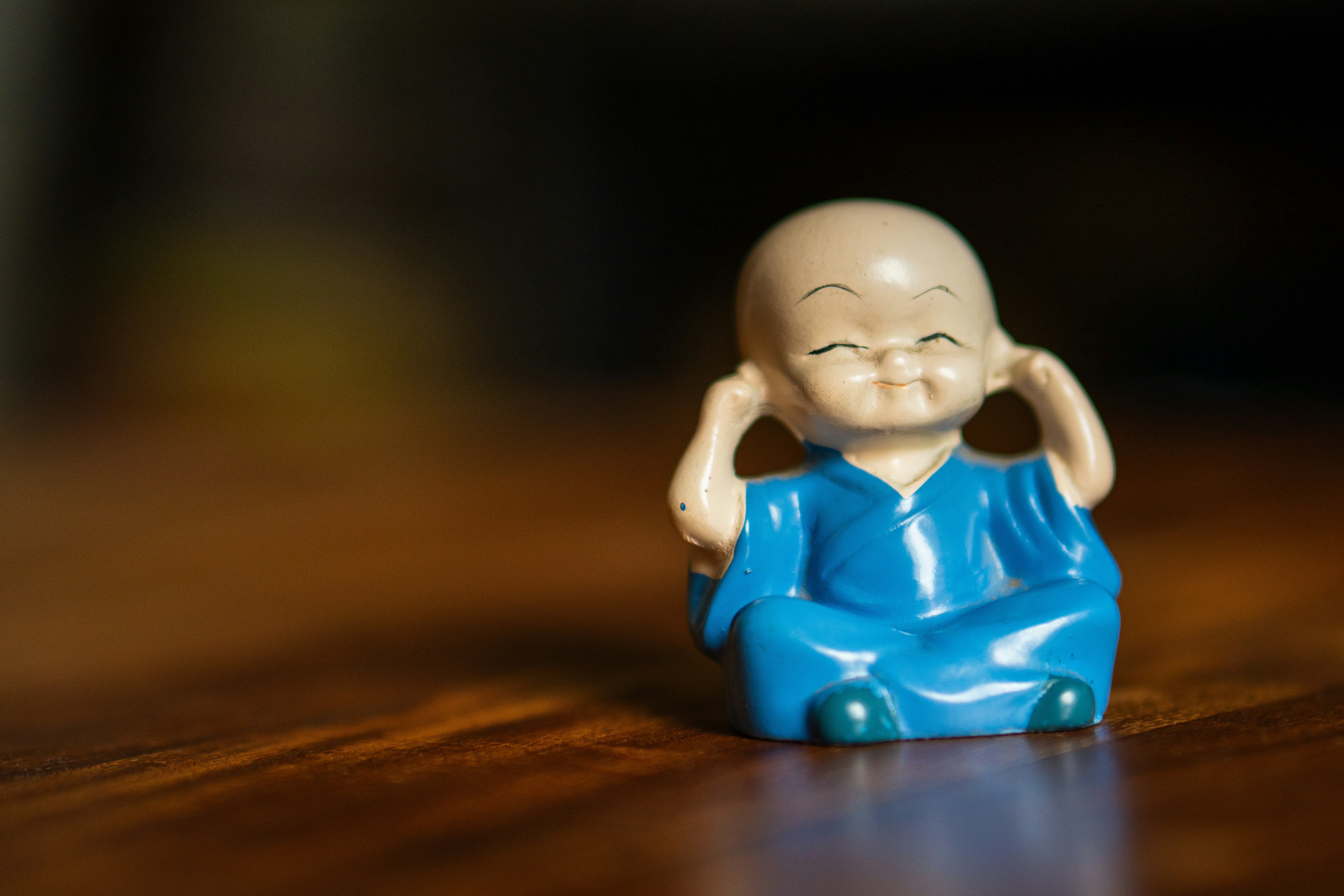 Zen Miniature: A Blue Robed Monk Toy Halting in Thought