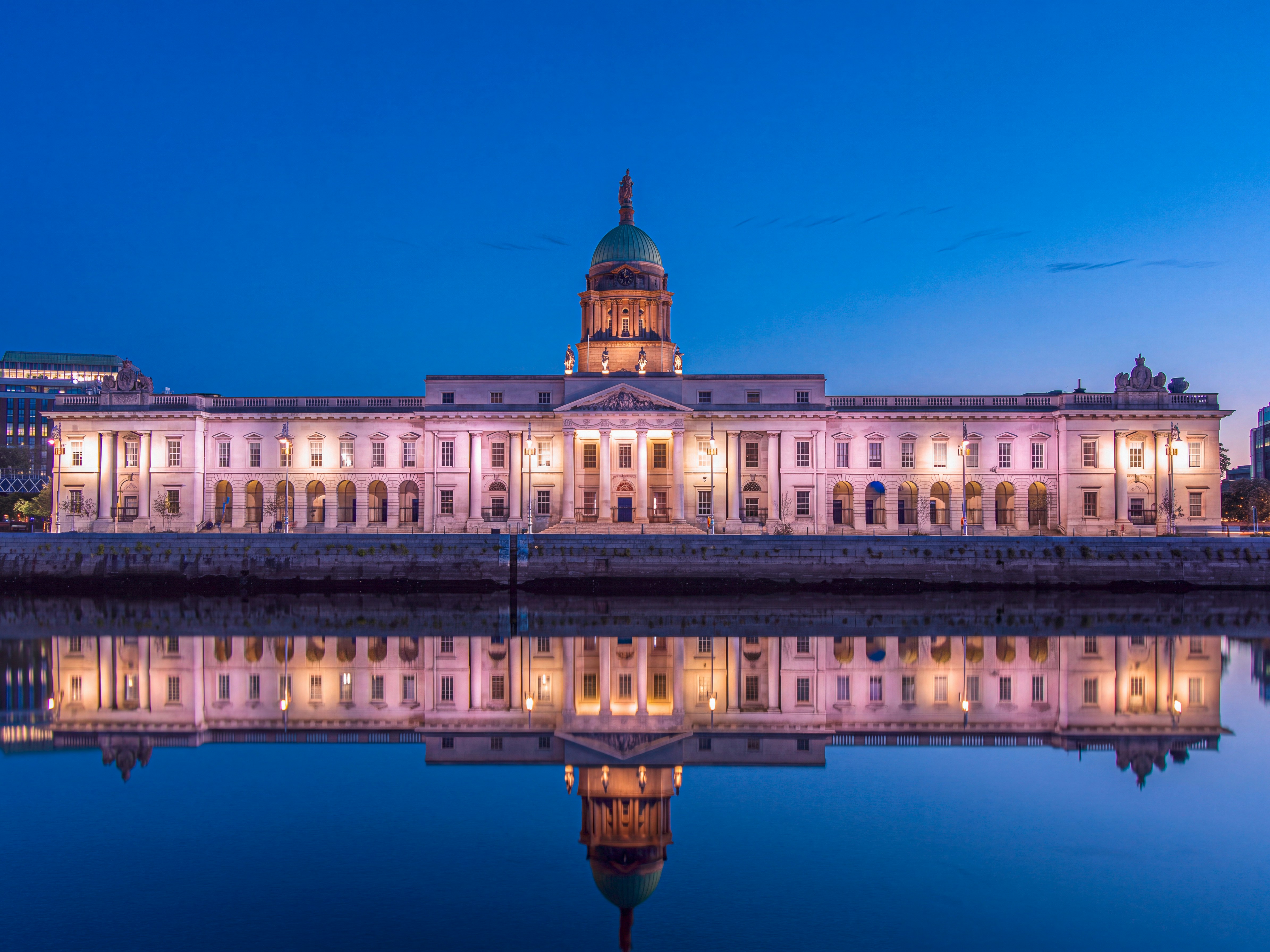 Twin Facades, Quiet Waters: The Balanced Grand Hall at Dusk