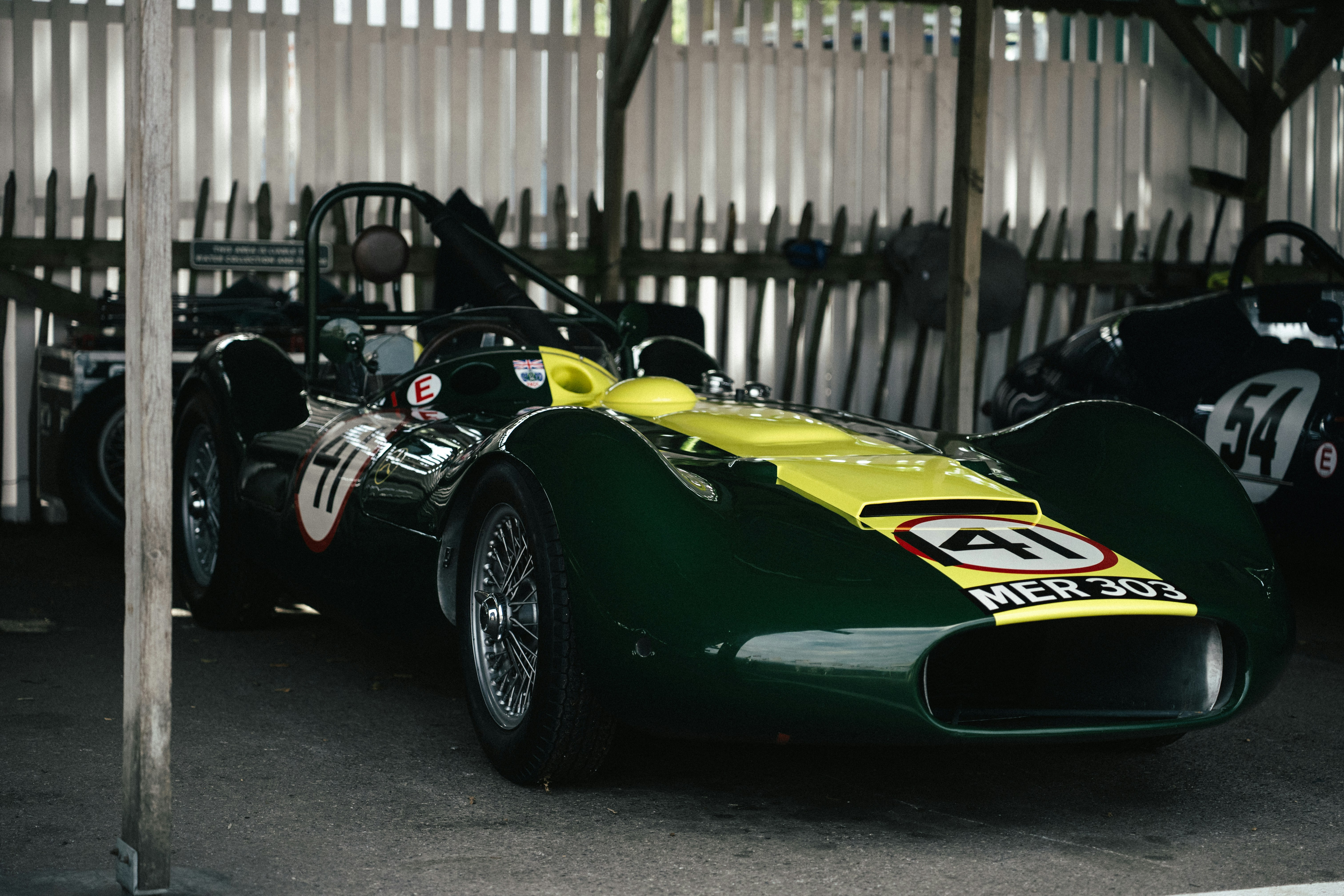 Yellow-Accented Classic Race Car in Dim Barn