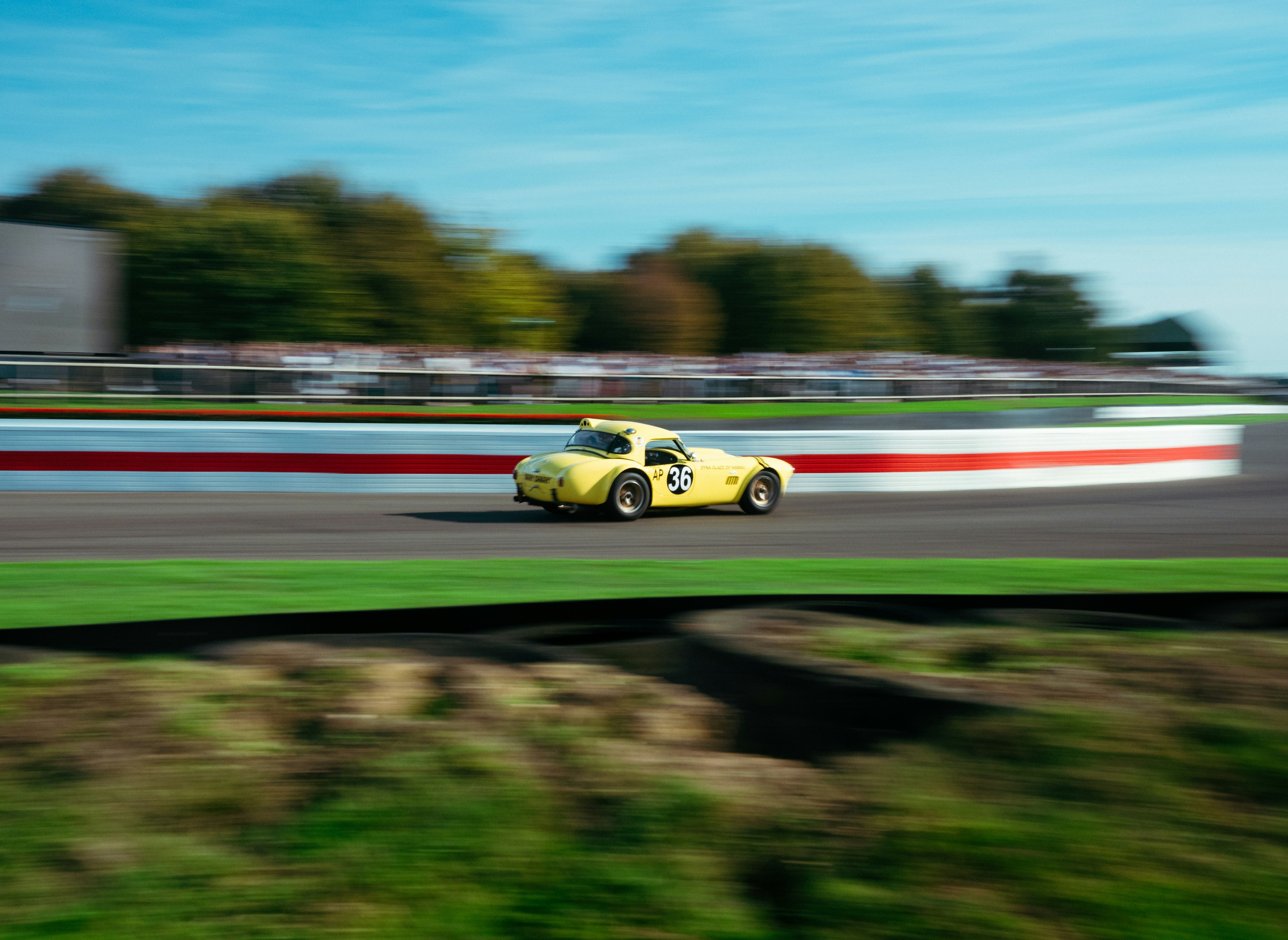 Yellow racer in a blur of speed: a bright moment on the track