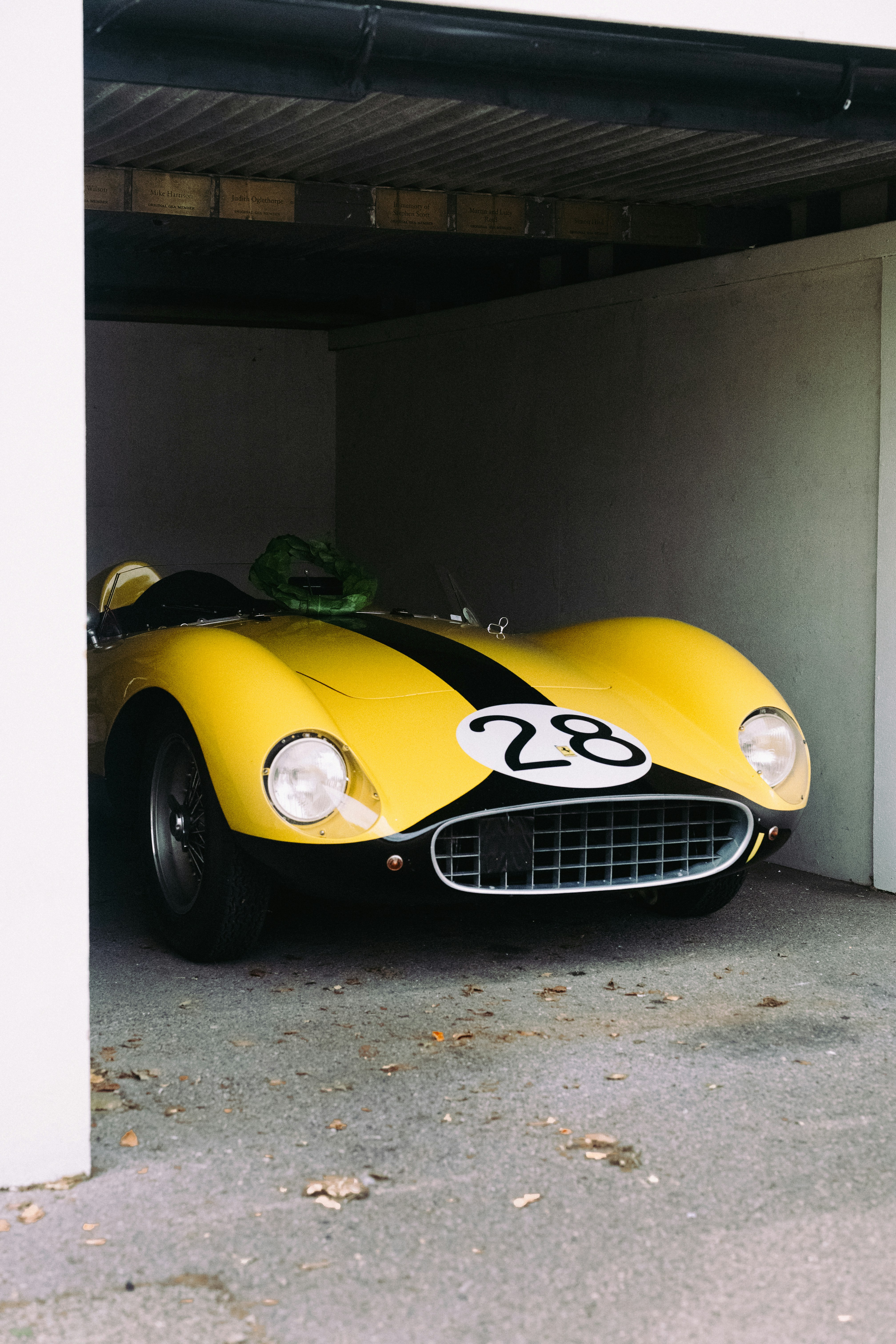 Yellow Racer in a Dim Garage: Classic Car’s Bold Stride