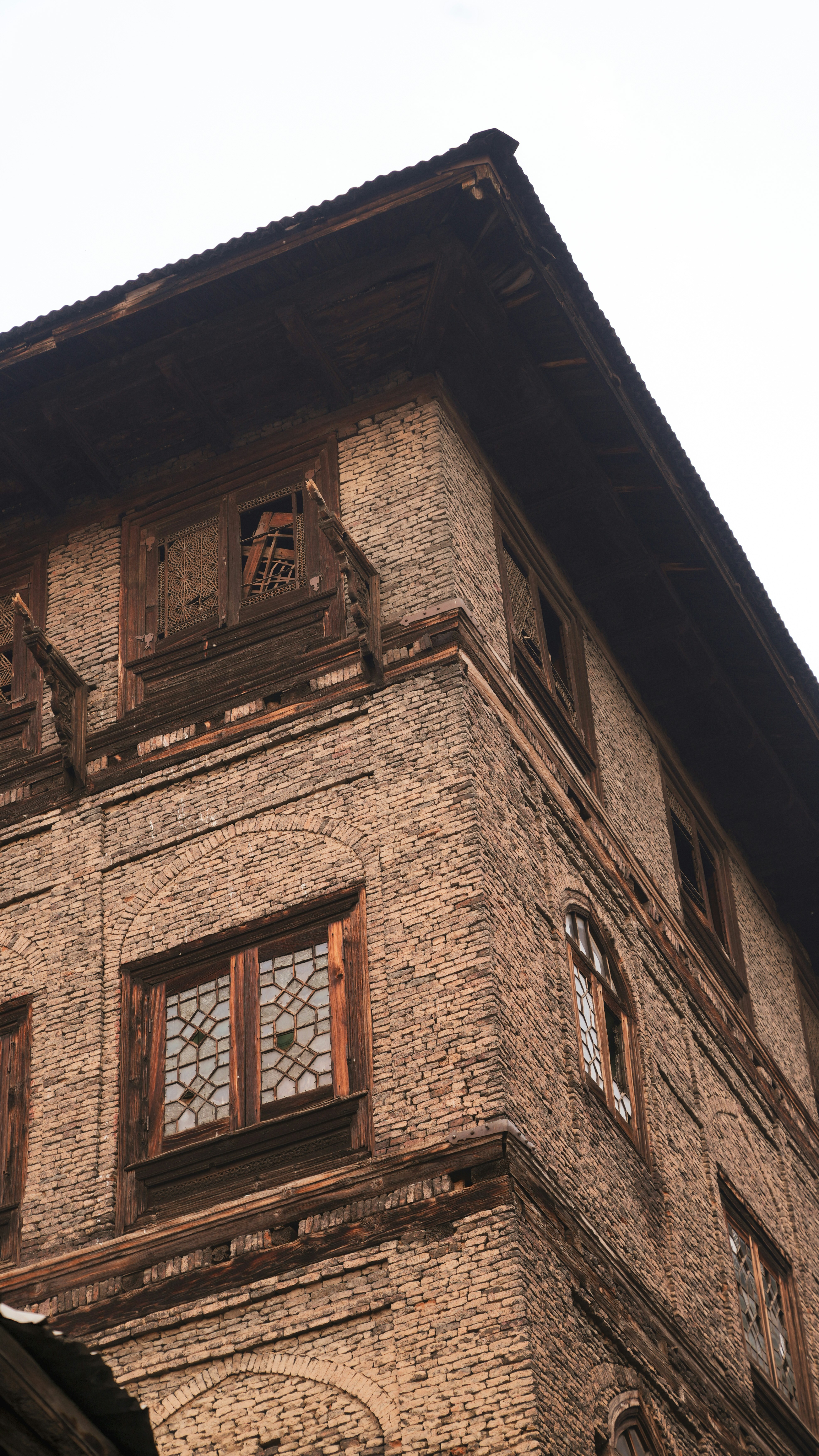 Weathered Brick Manor: A Corner View into Timeless Woodwork