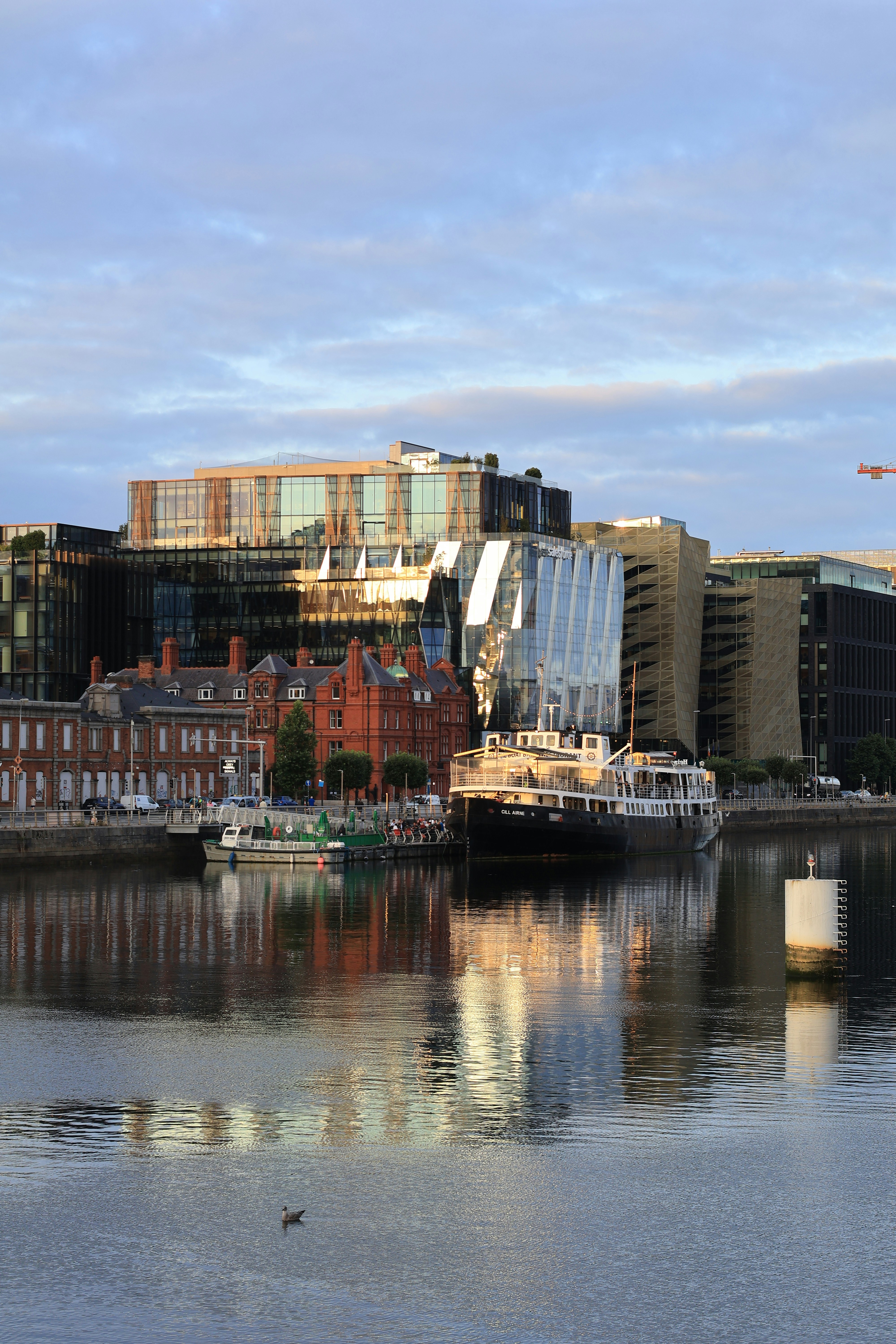 Harbor skyline with modern glass architecture reflecting on the river