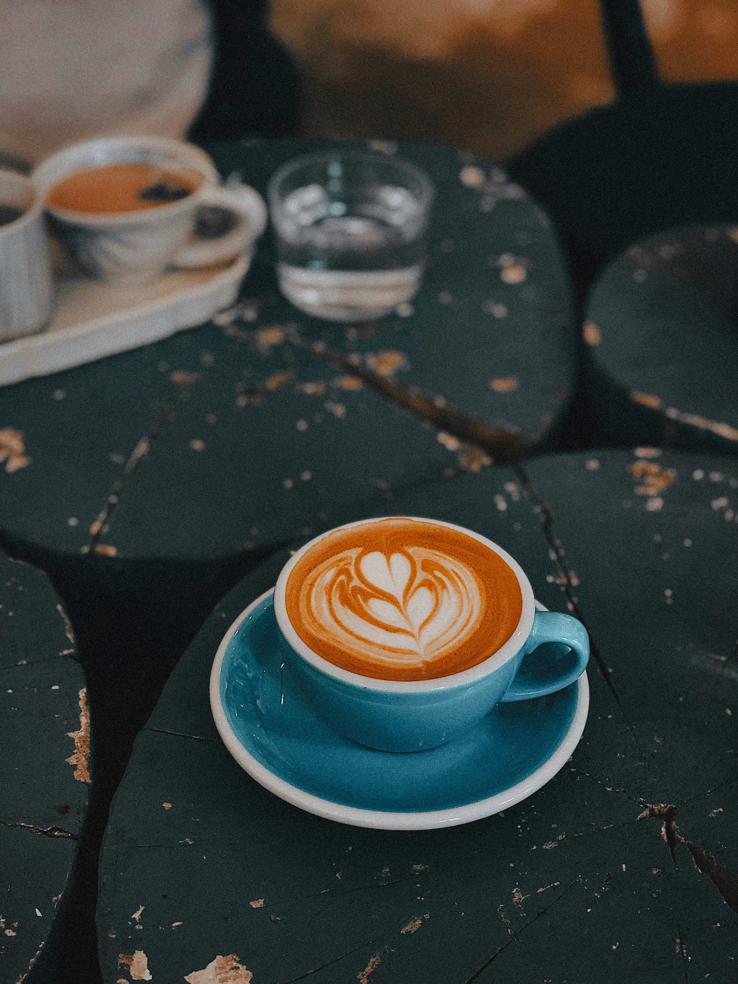 Cerulean Cup: Latte Art on a Weathered Table