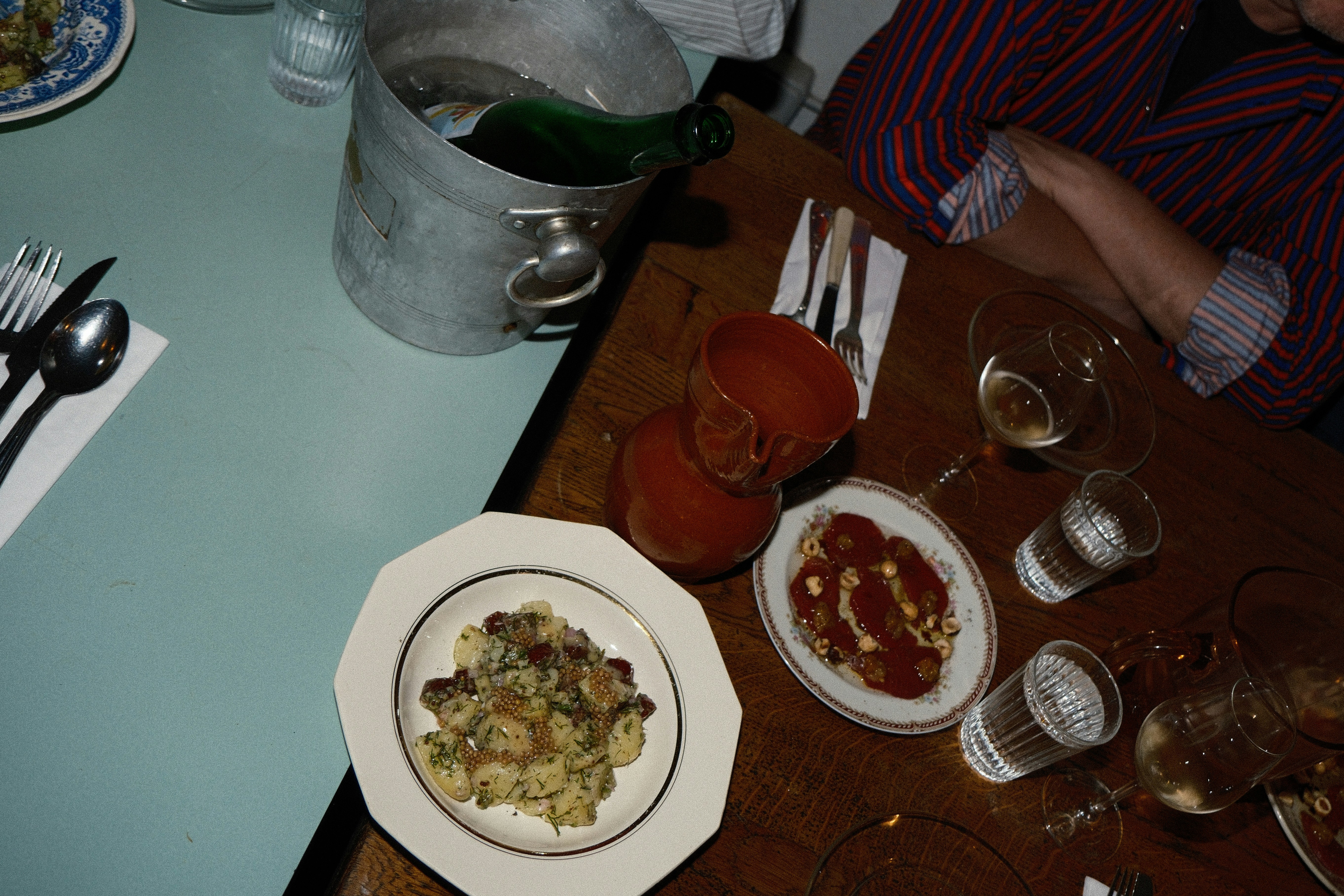 Shared Feast: Plates and Glassware Angle Over a Lunch Table