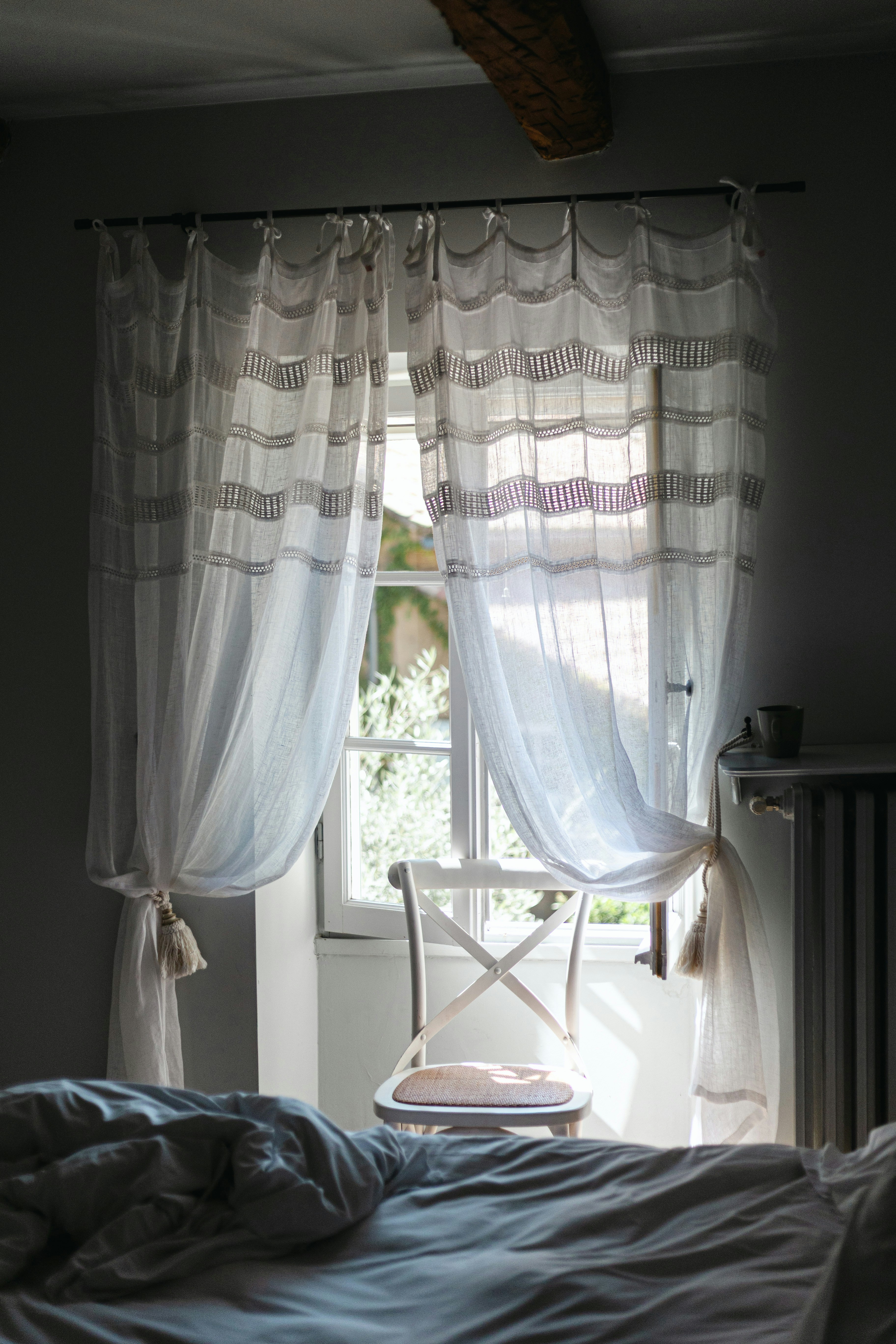 Sunlit Window Nook with Sheer Drapes and Quiet Chair