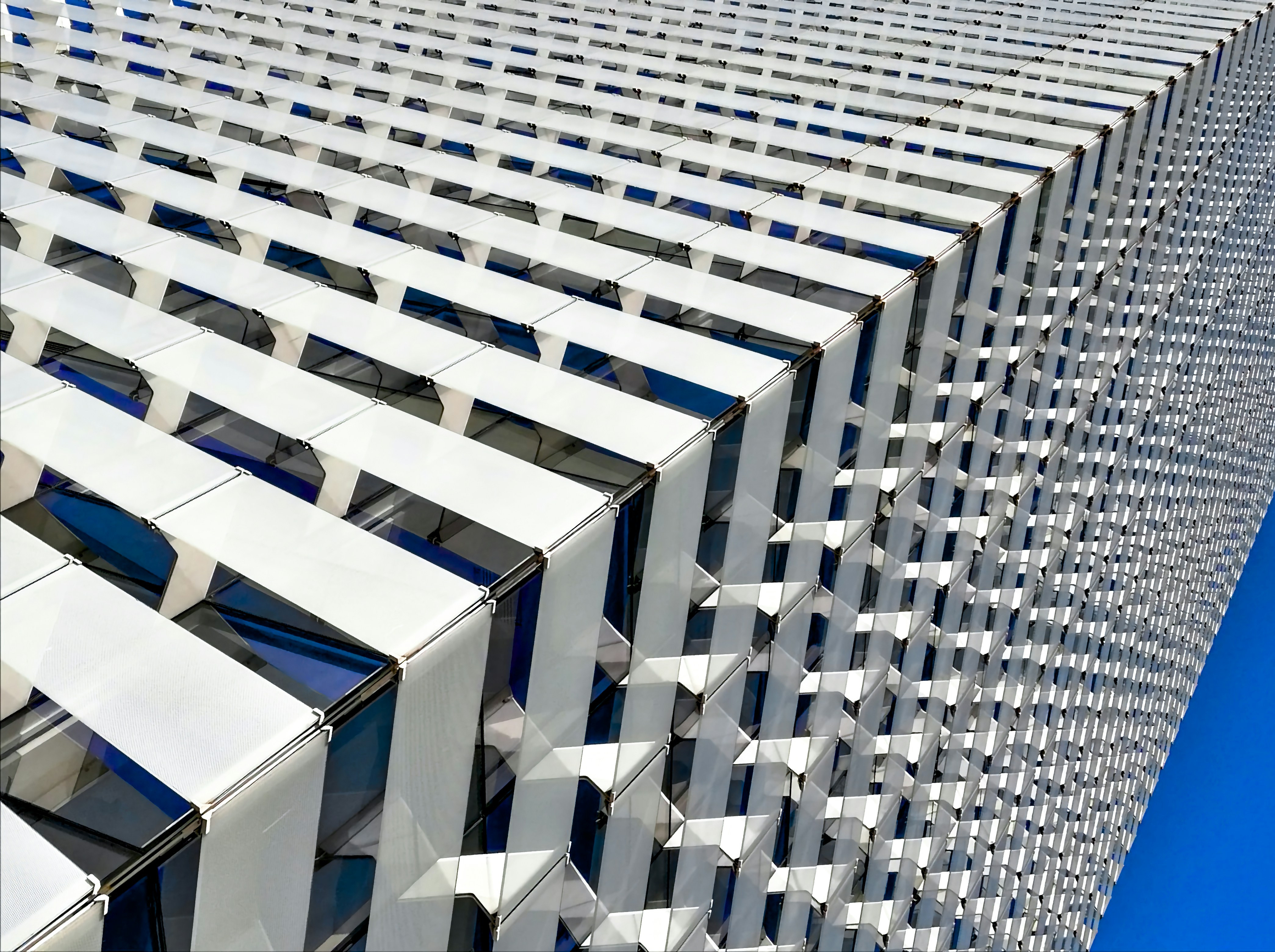 Diagonal Facade Rhythm: Repeating Aluminum Slats Catching Light and Shadow