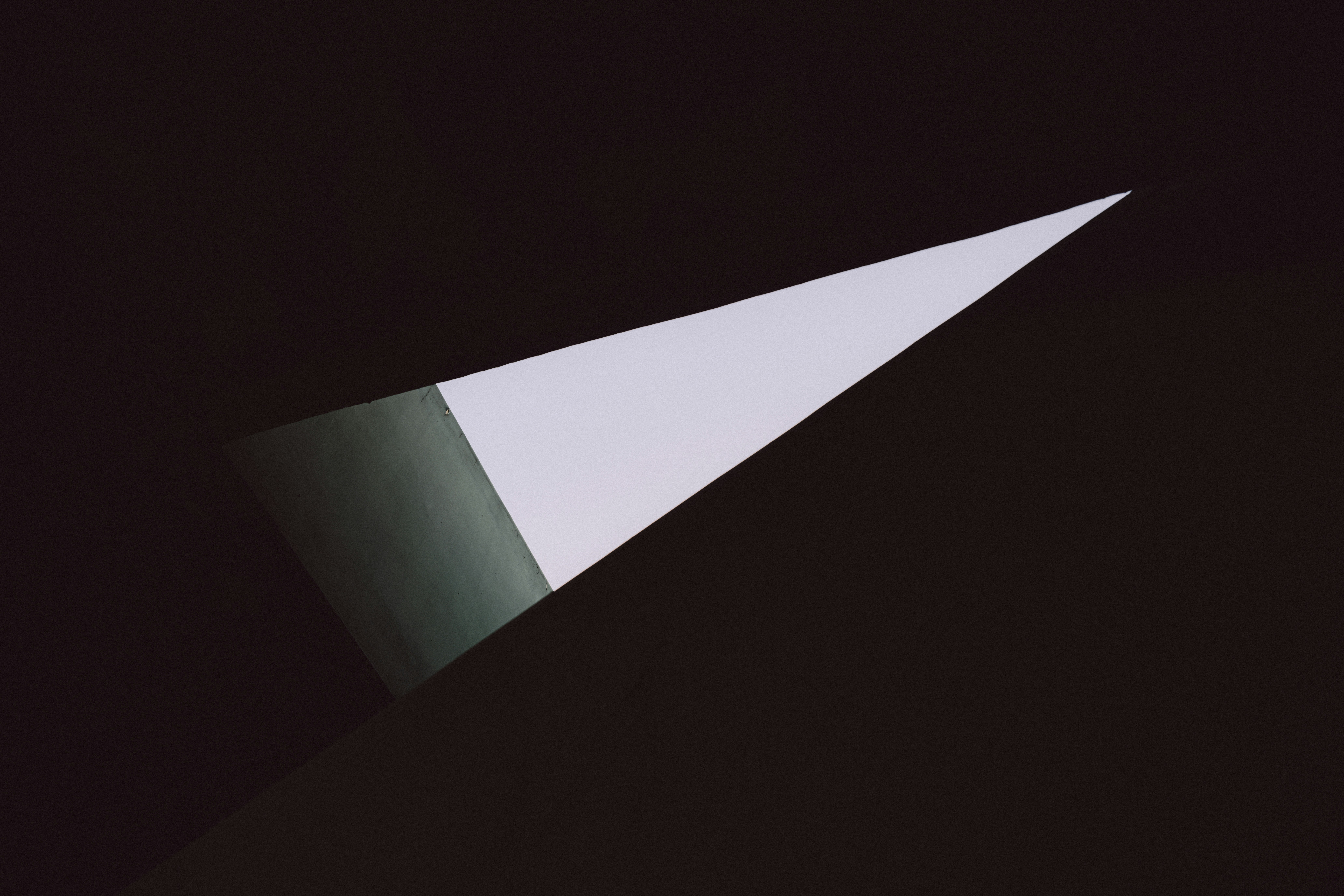 Triangular Aperture Piercing a Dark Sky