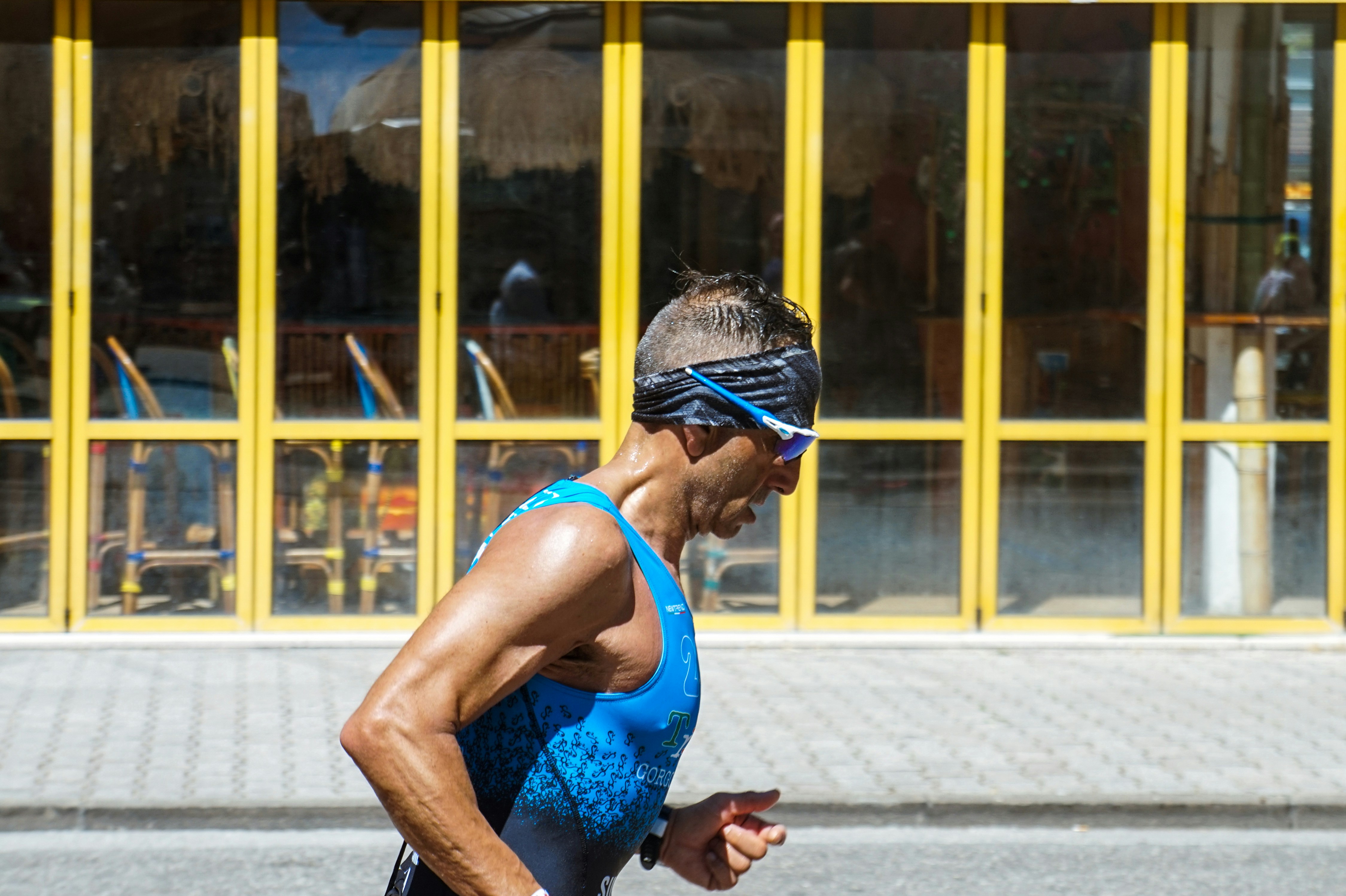 Blue-Trimmed Runner Against a Yellow-Framed Glass Wall