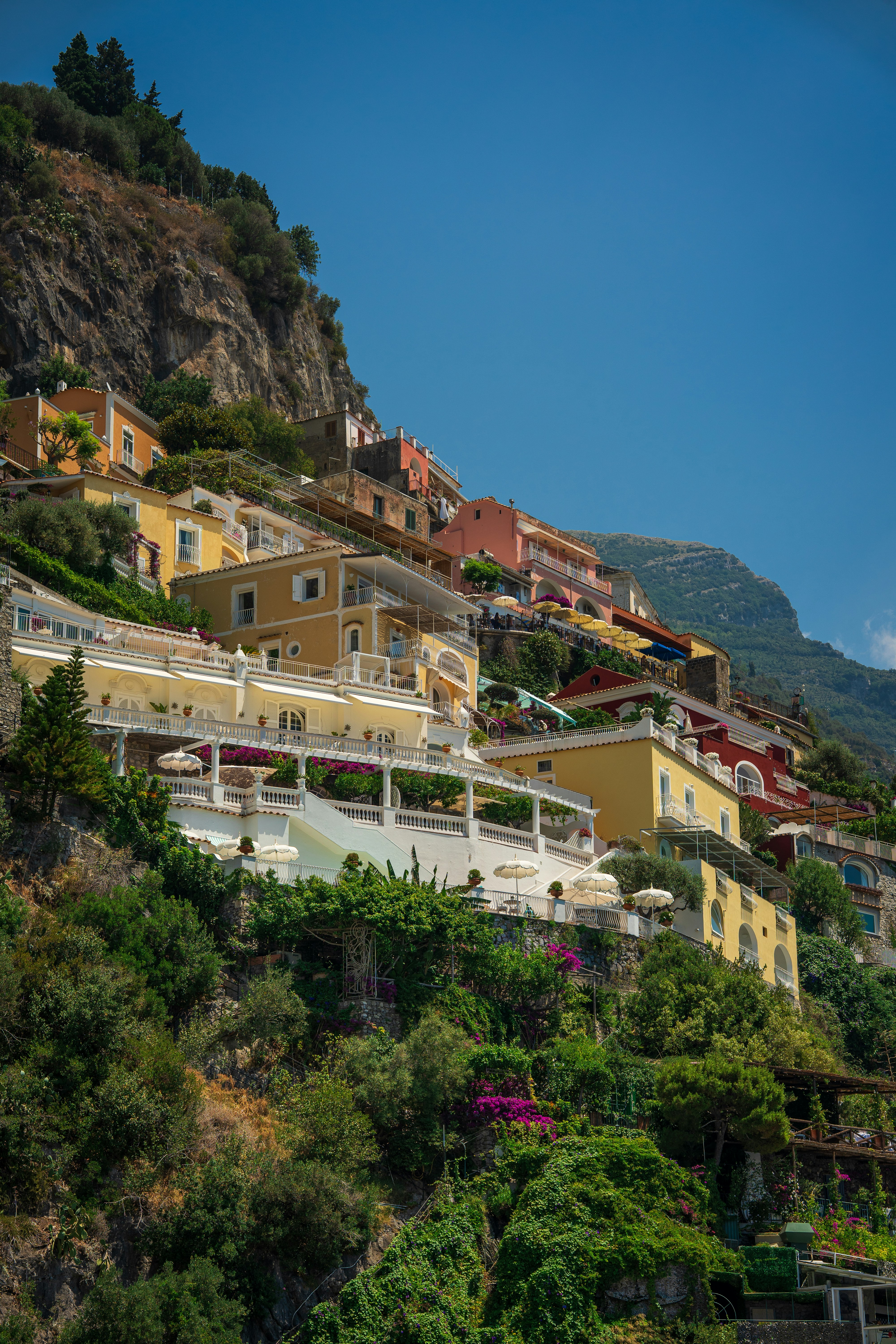 Vibrant hillside village cascade of color against a clear Mediterranean sky