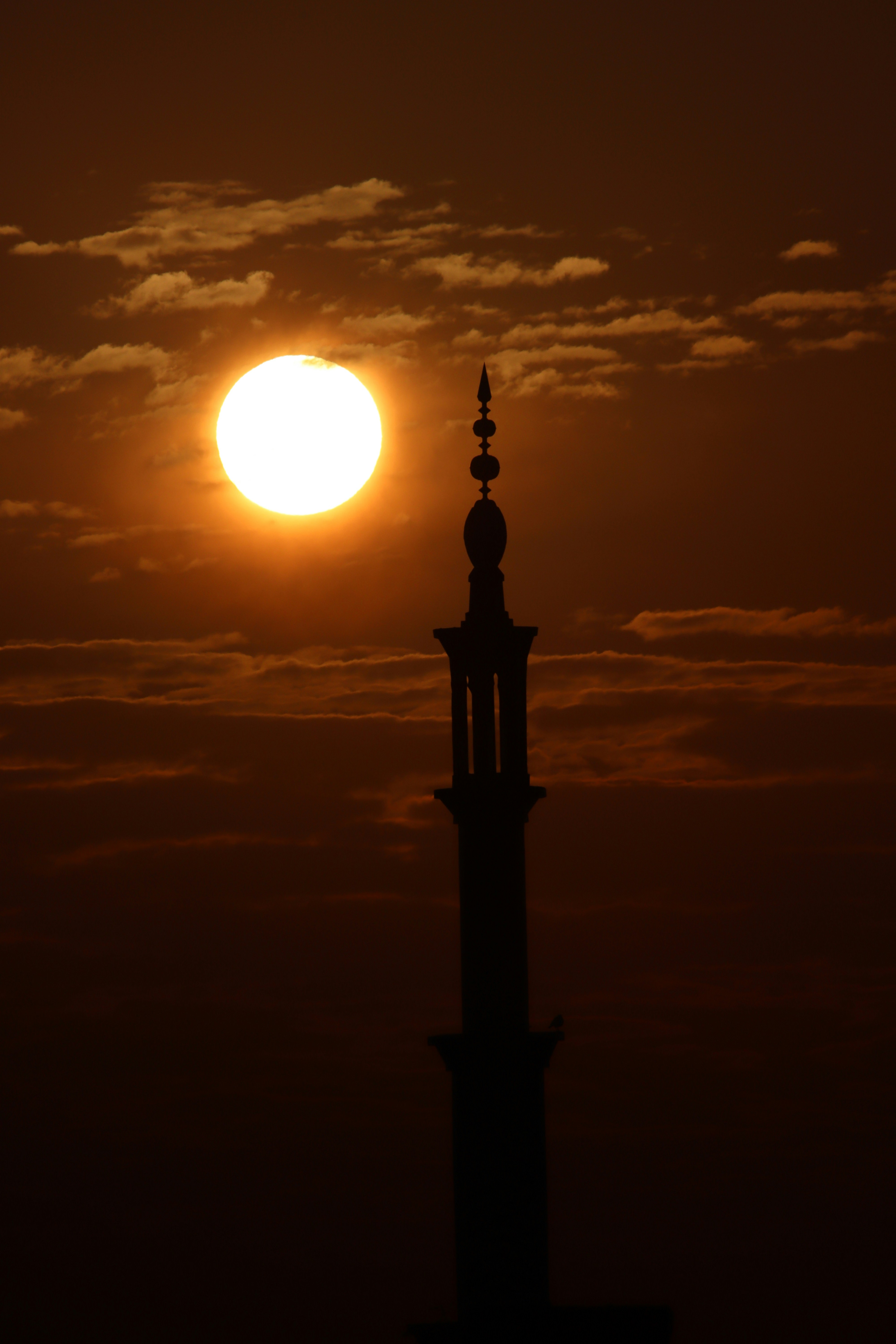 Sunlit Spire: A Silhouette Against a Fiery Horizon