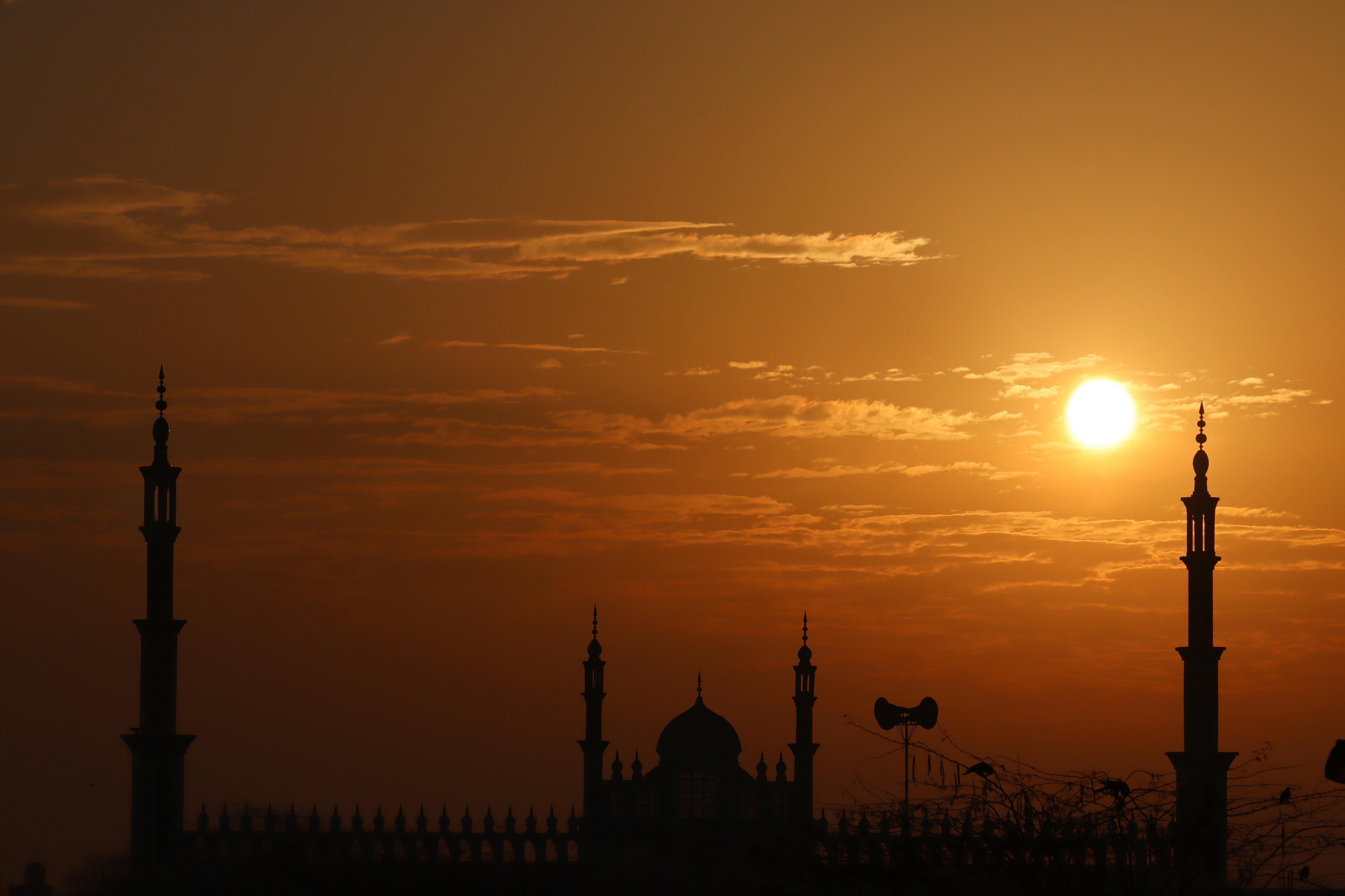 Silhouetted Minarets at Dusk: A City Horizon in Flame