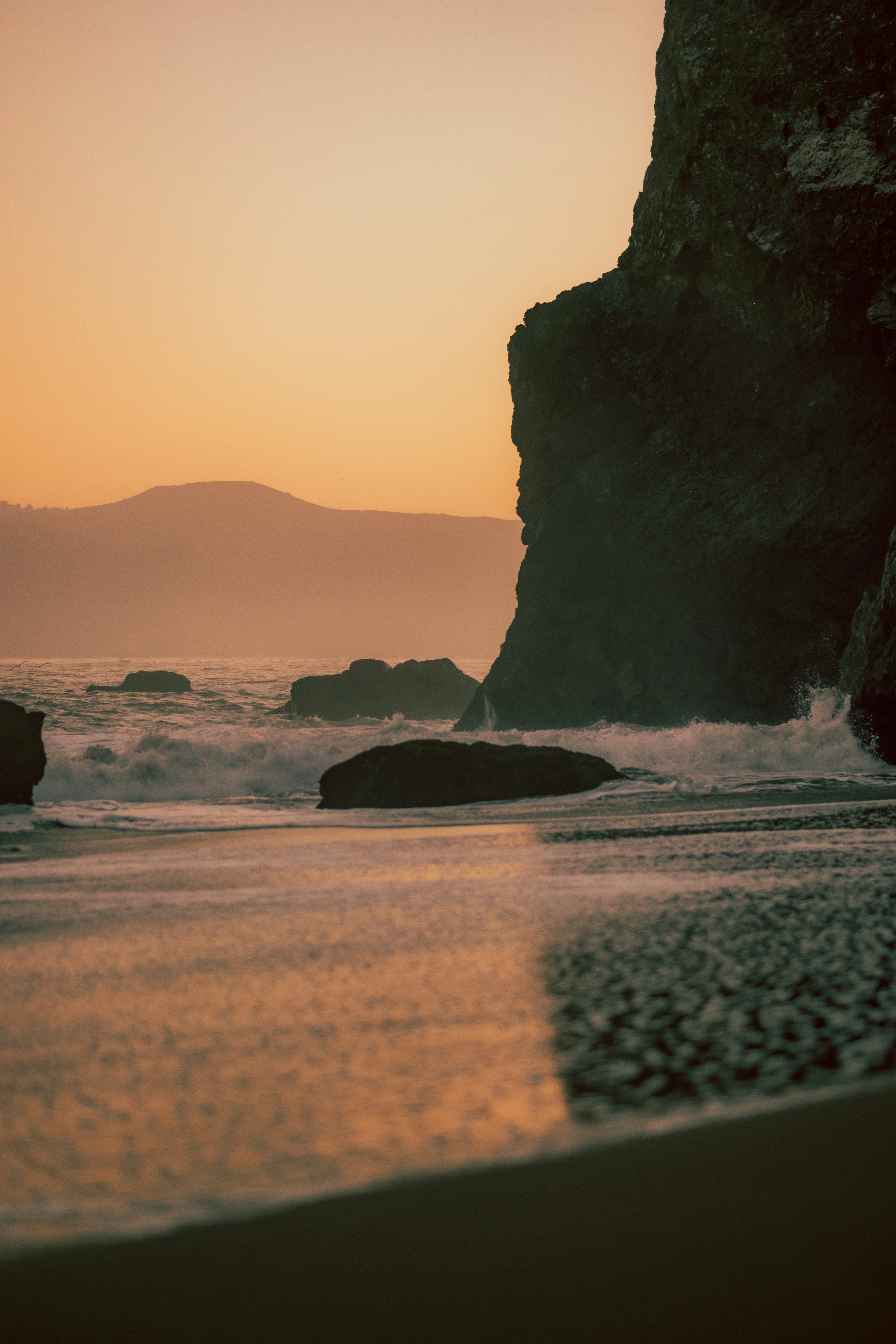 Sunset Against a Cliff: Quiet Shoreline Between Light and Shadow