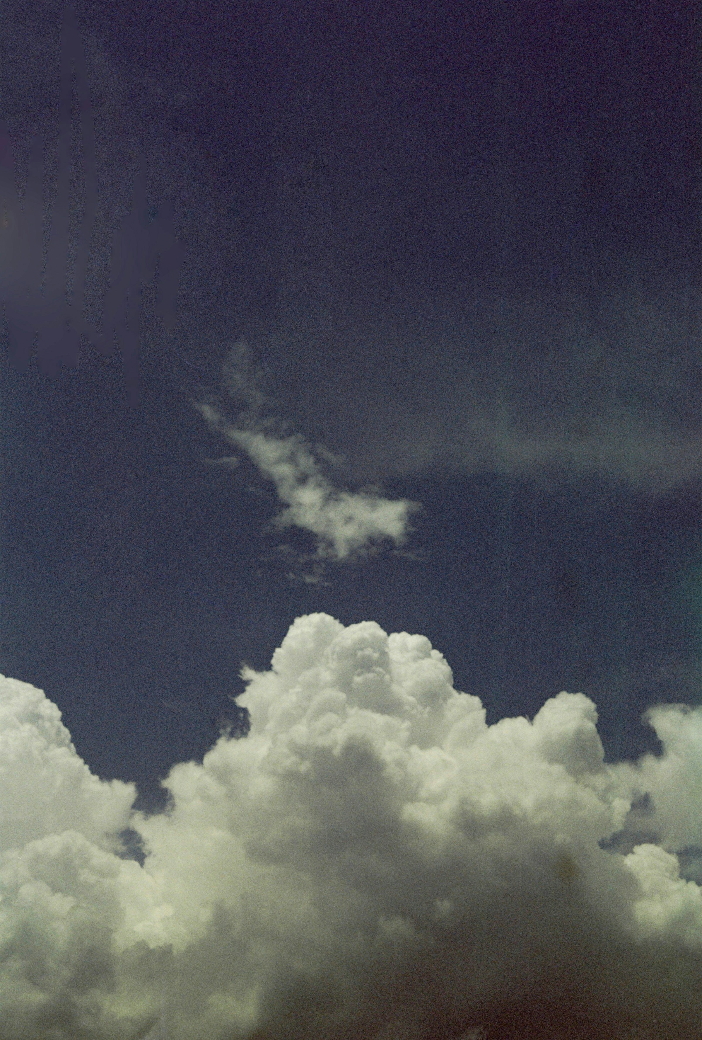 Colossal Clouds Breaching a Deep Sky