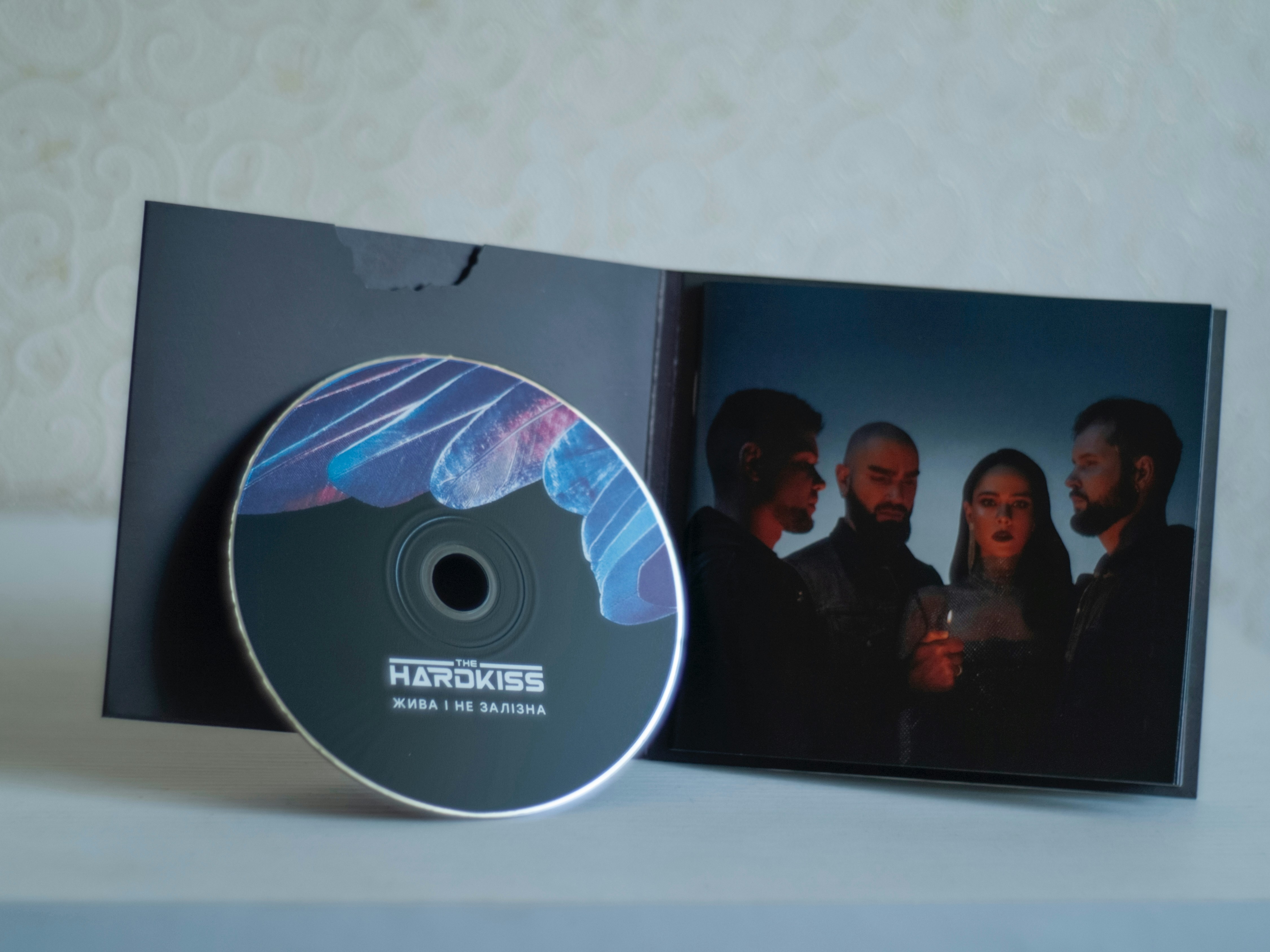 Neon Reflections: a CD and open sleeves in quiet studio light