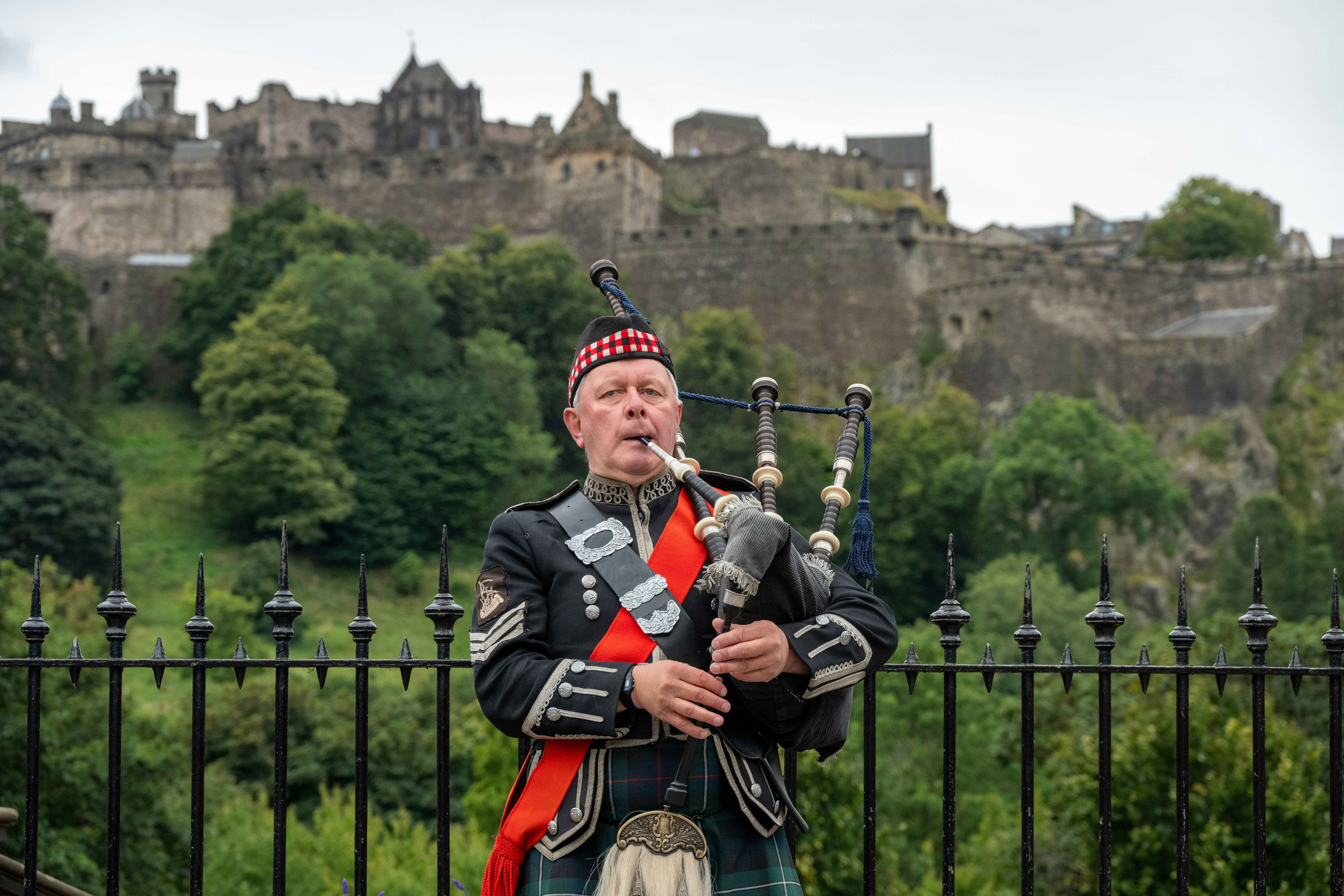 Drums of Edinburgh: A Highland Bagpiper Stands Guard at the Castle Ridge