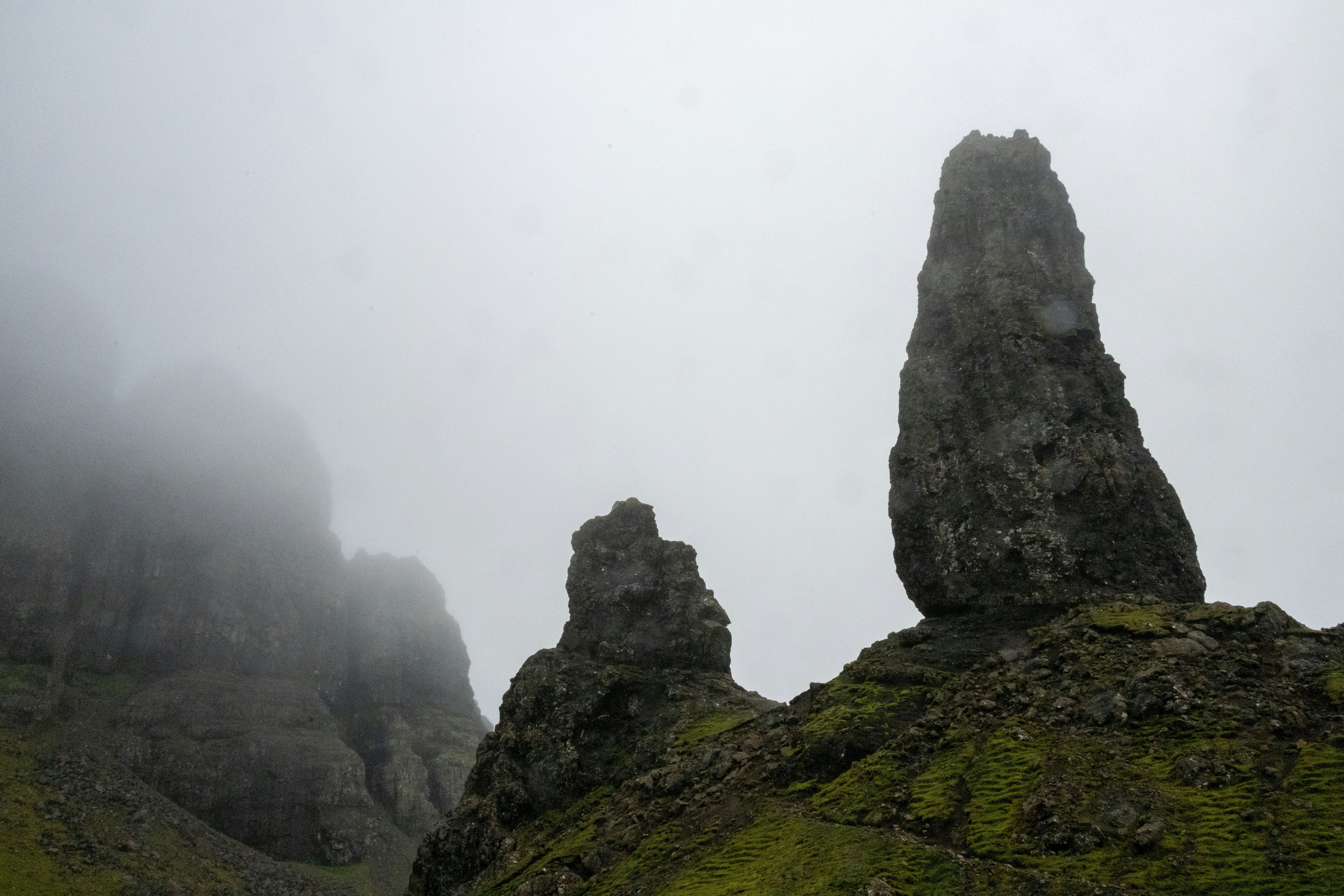 Mist-veiled Spires Rising from a Mossy Ridge