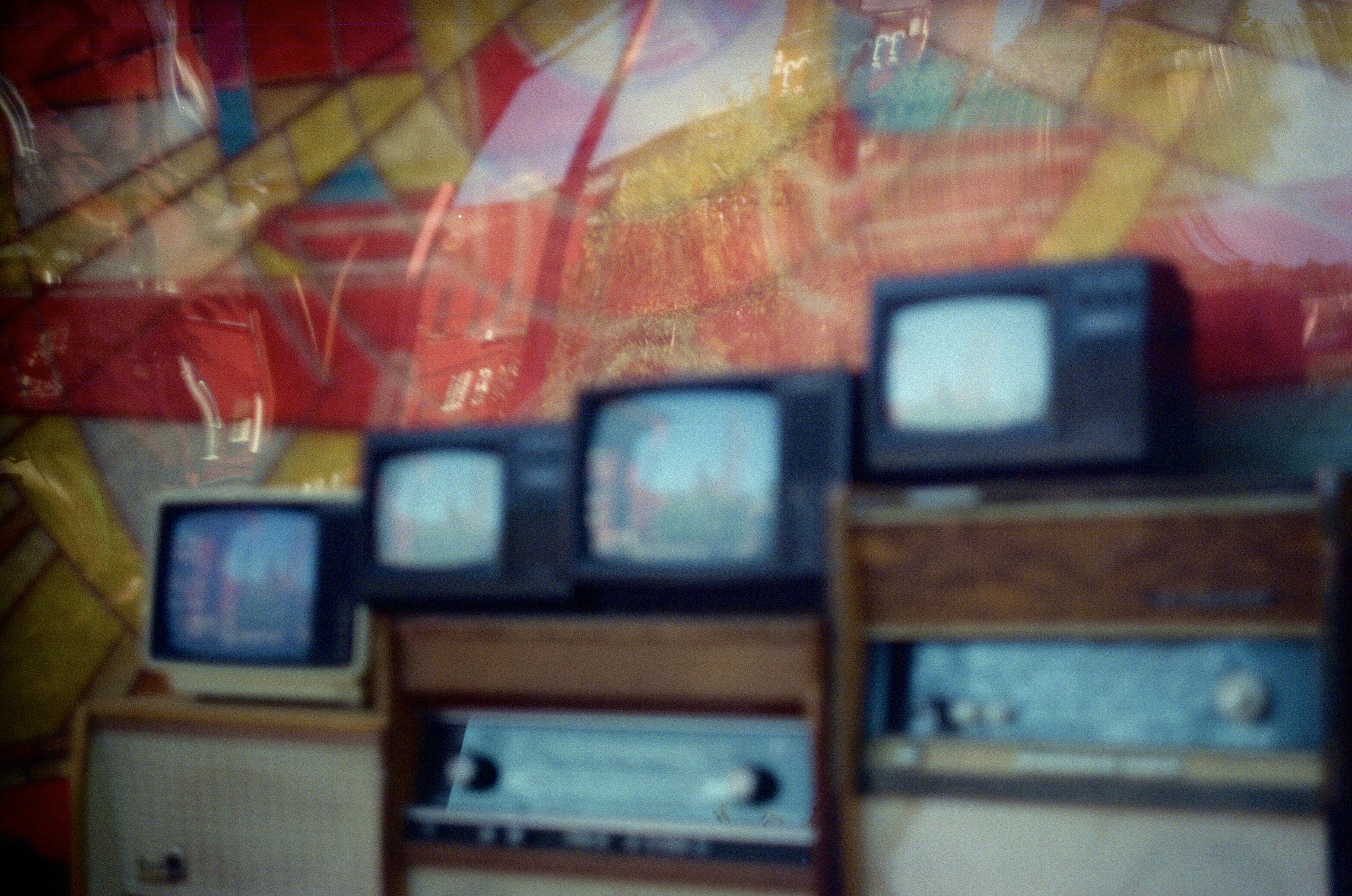 Retro Broadcast Still Life: Distant Screens in a Hazy Shop Window